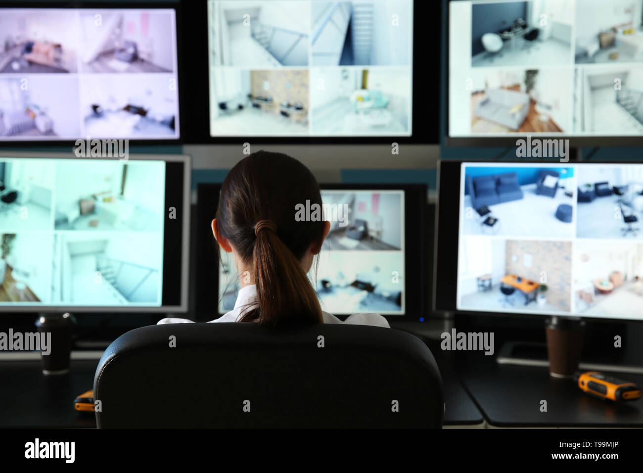 Security guard monitoring modern CCTV cameras in surveillance room ...