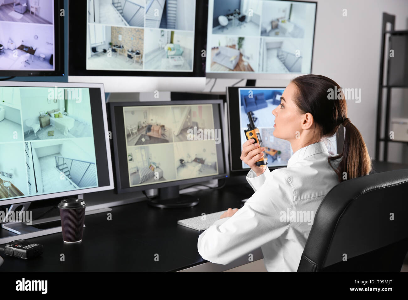 Security guard monitoring modern CCTV cameras in surveillance room ...