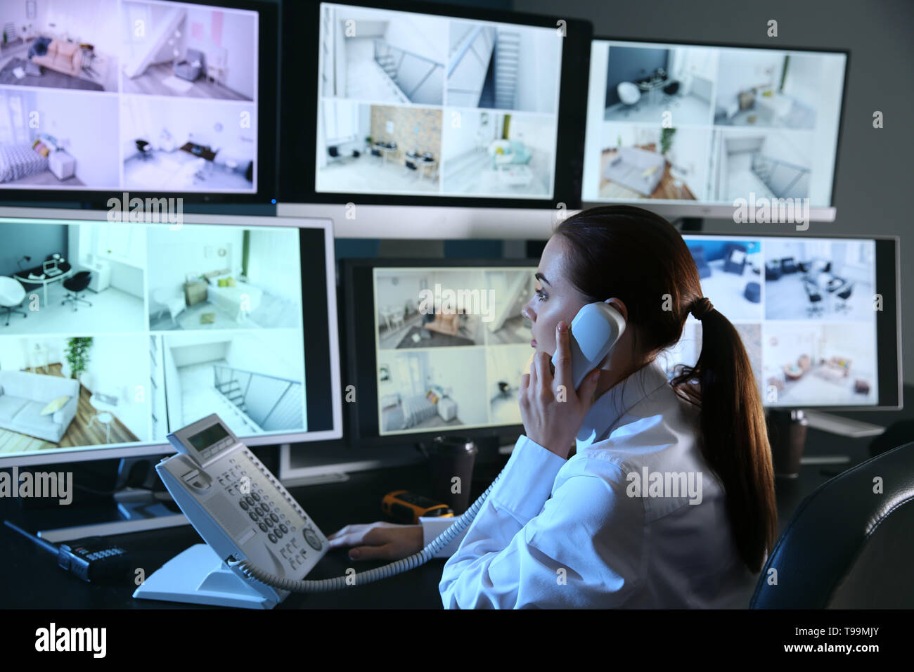 Security guard monitoring modern CCTV cameras in surveillance room ...