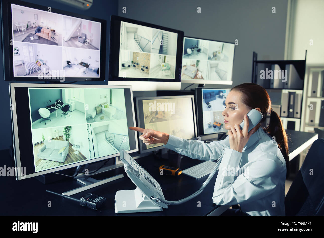 Security guard monitoring modern CCTV cameras in surveillance room ...