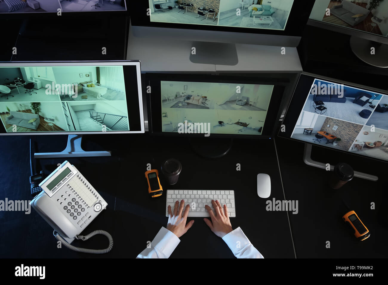Security guard monitoring modern CCTV cameras in surveillance room ...