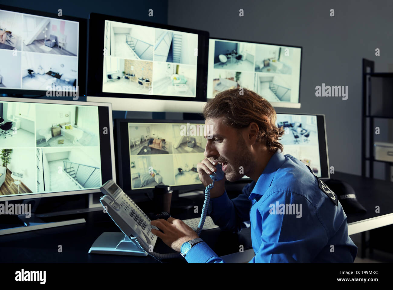 Security guard monitoring modern CCTV cameras in surveillance room ...