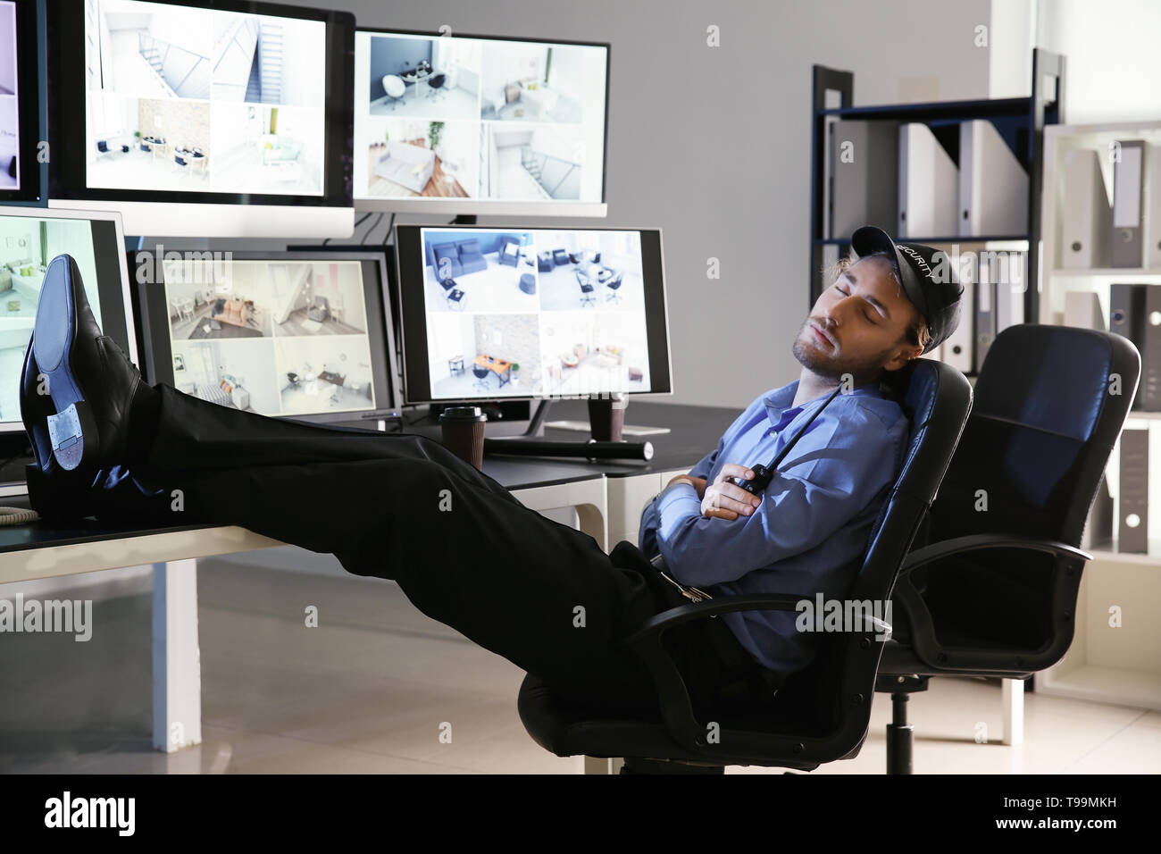 Security guard sleeping in surveillance room Stock Photo - Alamy