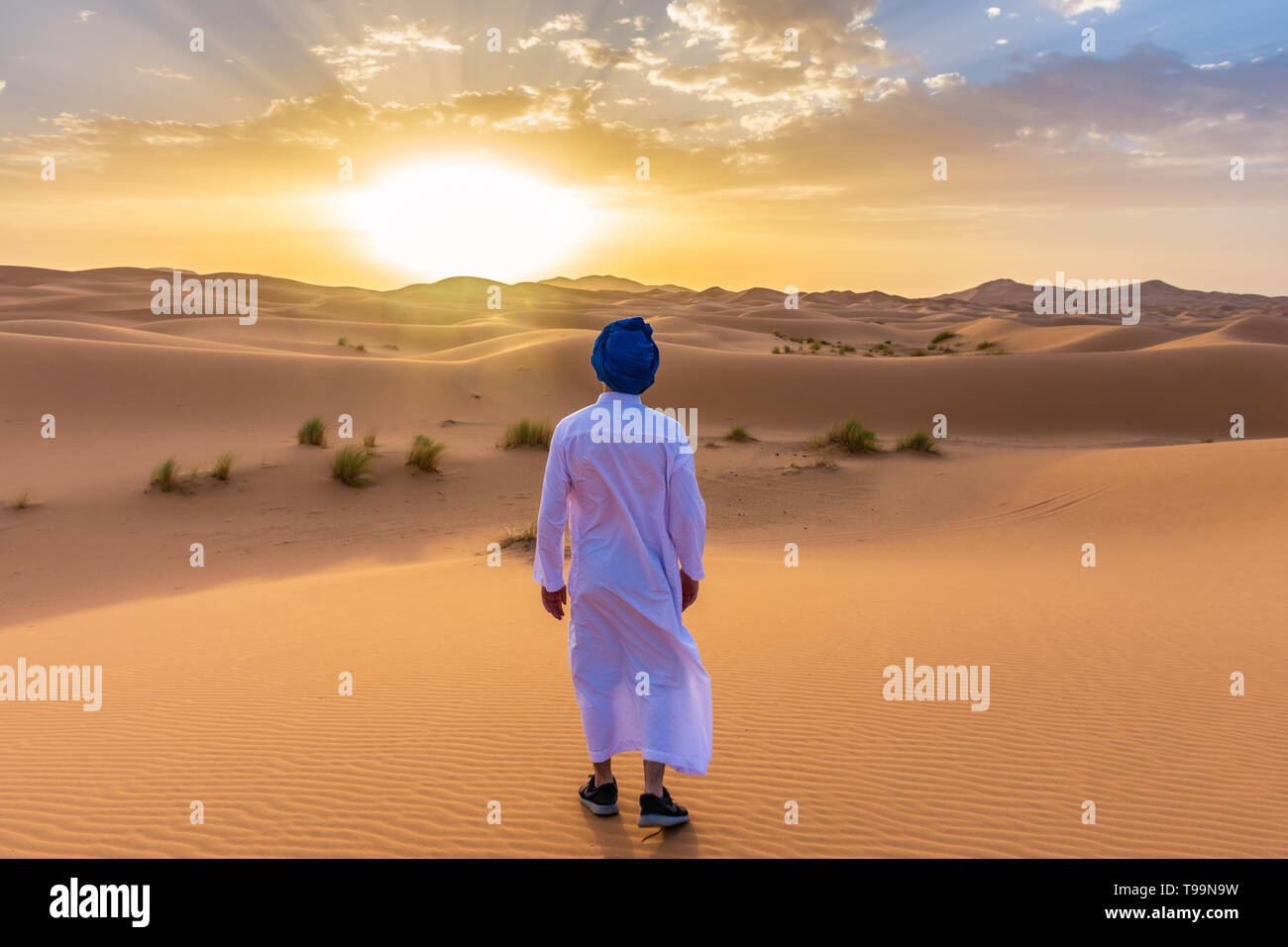 Berber man wearing traditional clothes in the Sahara Desert at dawn ...