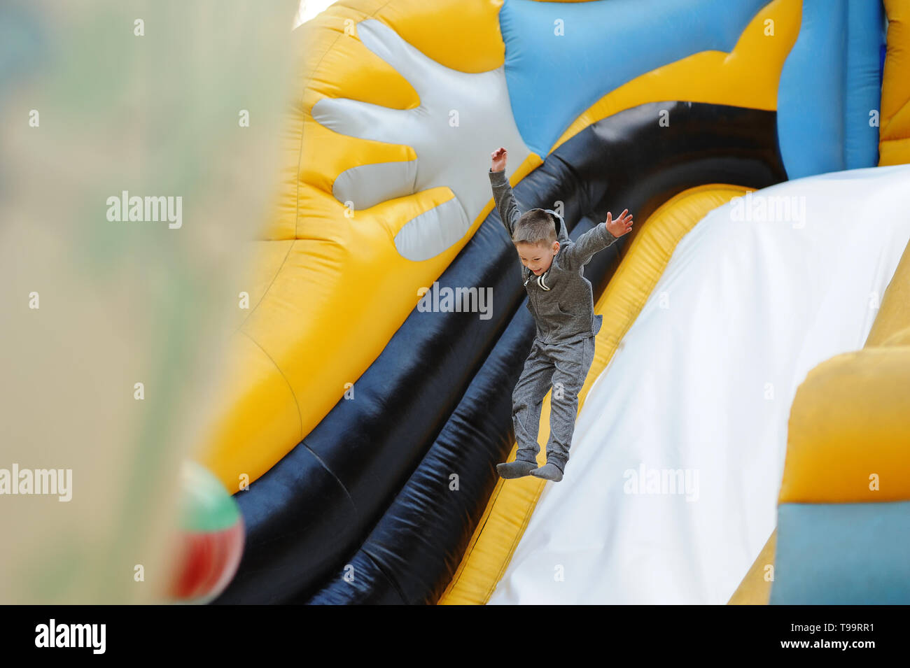 boy yellow jumping on a trampoline in an amusement Park Stock Photo - Alamy