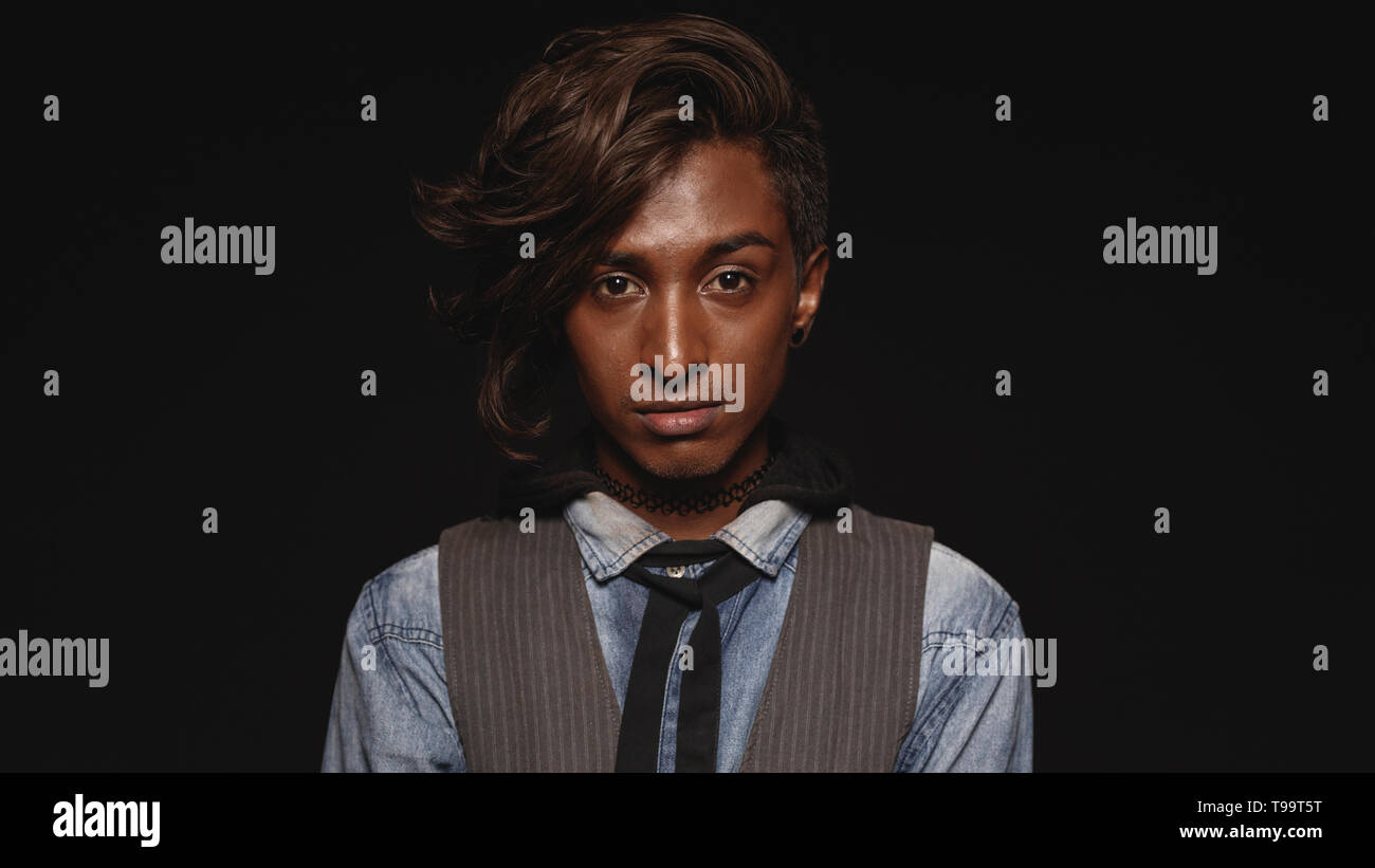 Fashionable indian male isolated on black background. Close up of young ...