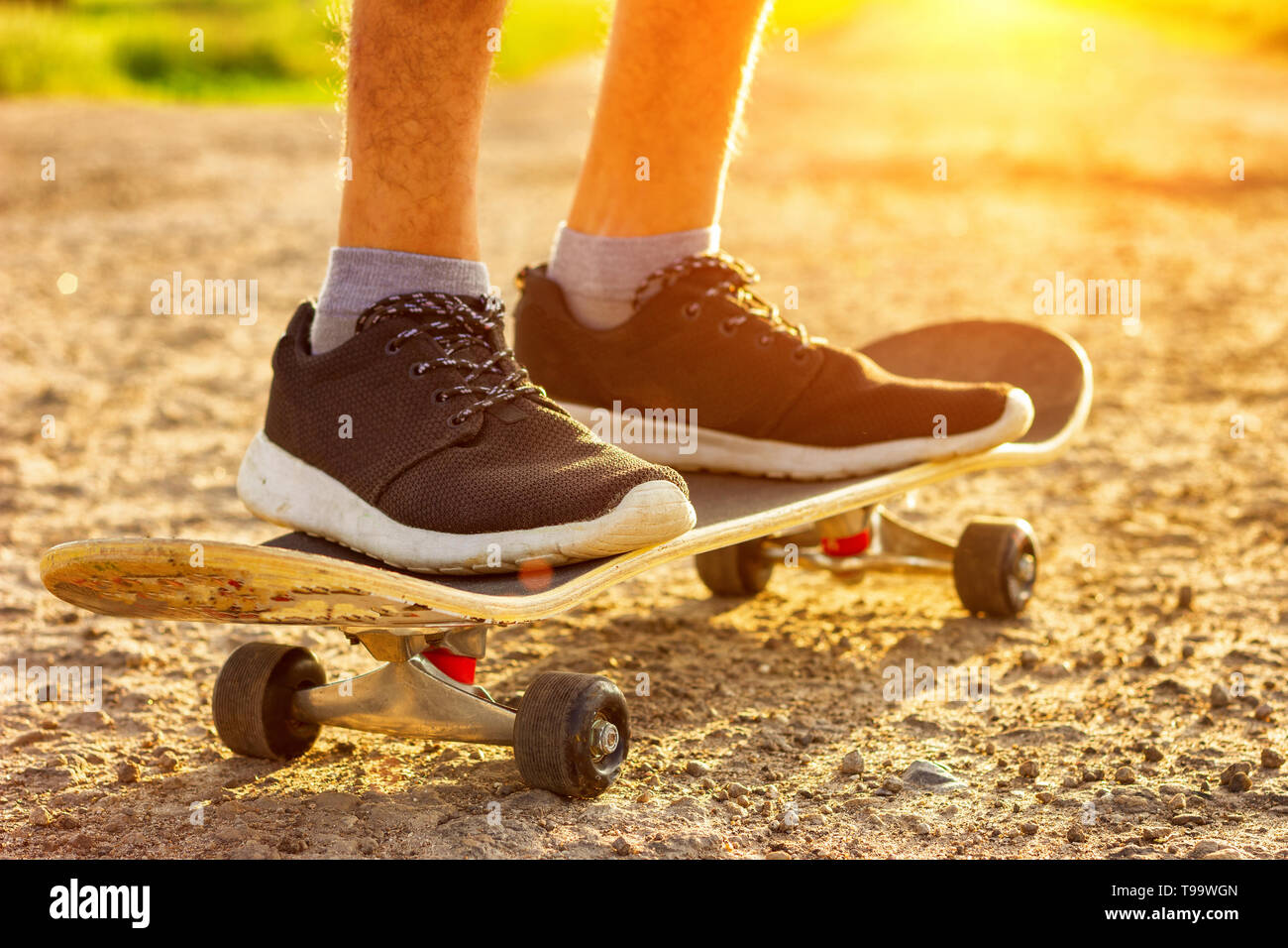 skateboarding on the road at sunset , summer entertainment Stock Photo ...