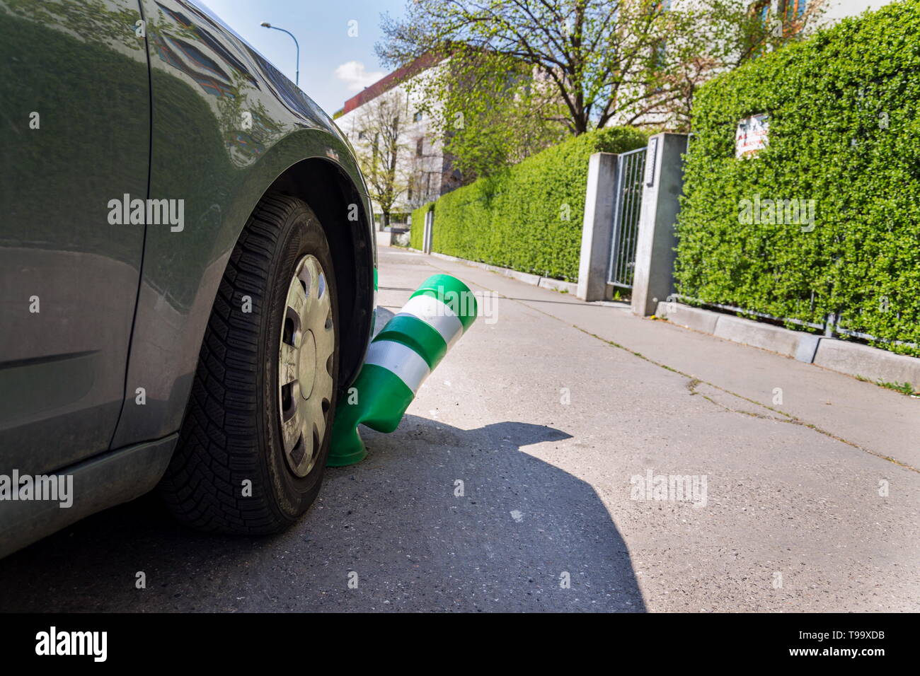 Car bending white and green safety traffic post with front bumper ...