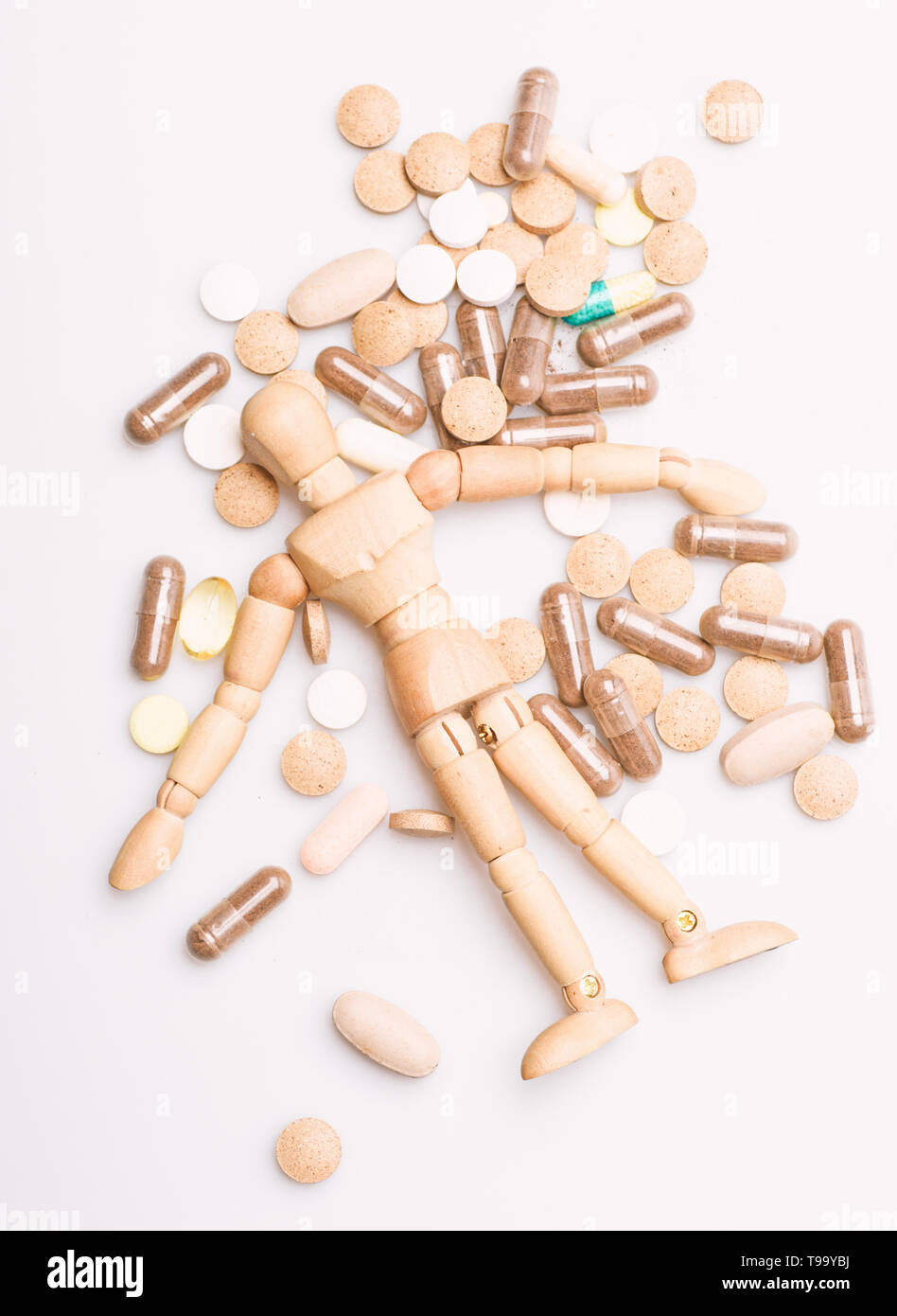 Medicine prescription. Wooden human dummy lay on pile of pills and ...