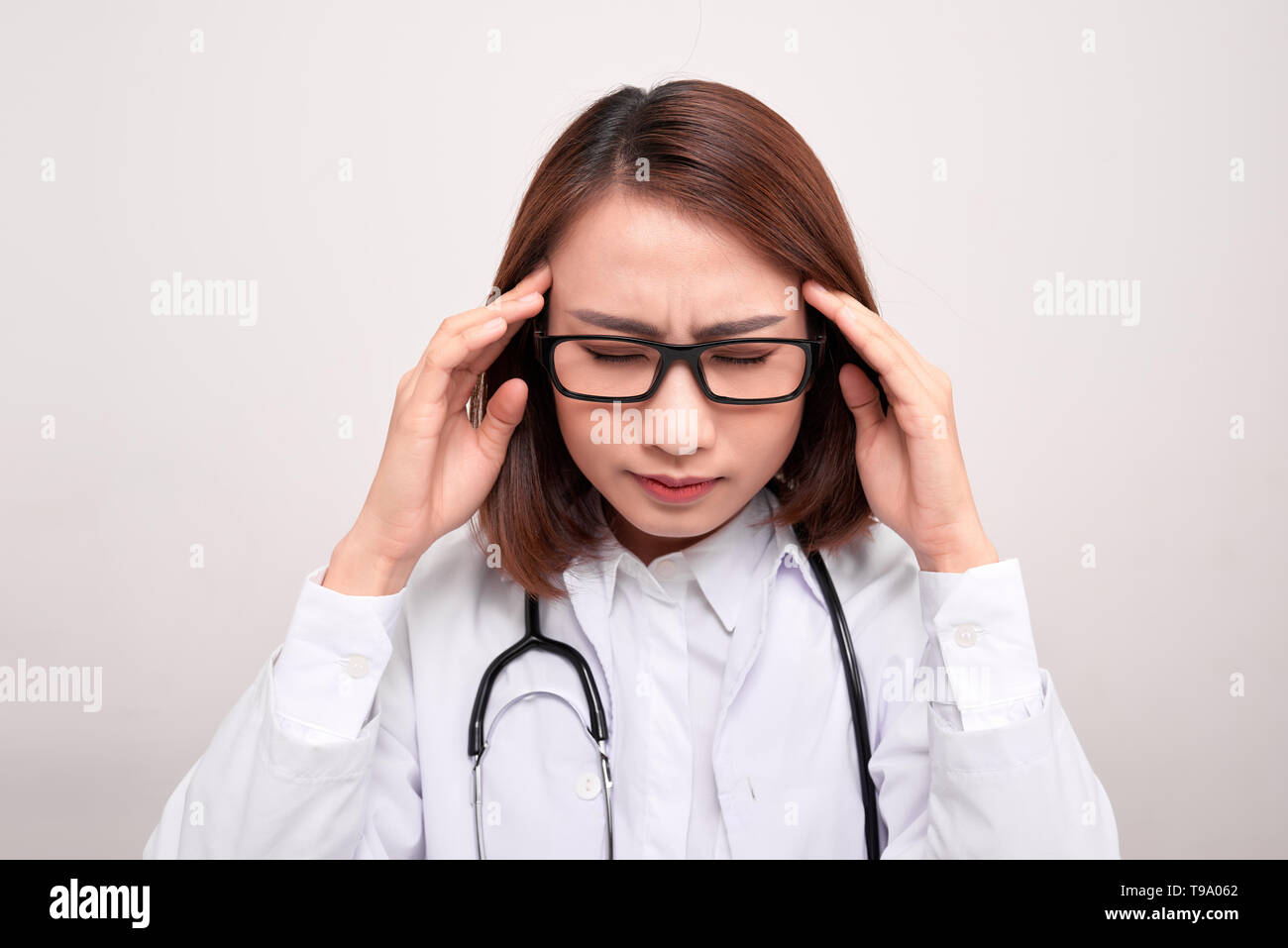 medical doctor woman with stethoscope problem, hold hand head on white ...