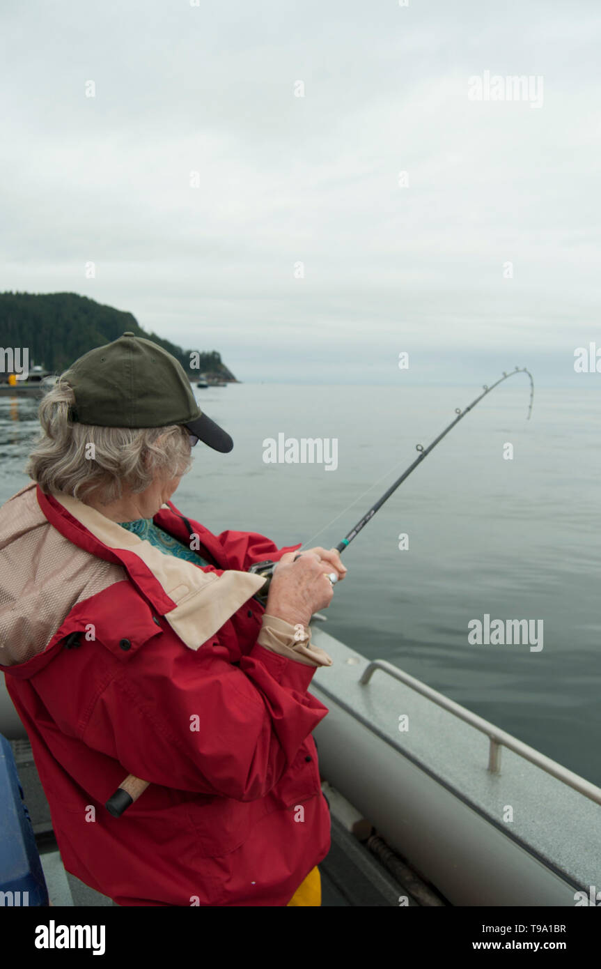 Diane Wilson plays a Chinook salmon while fishing out of Waterfall ...