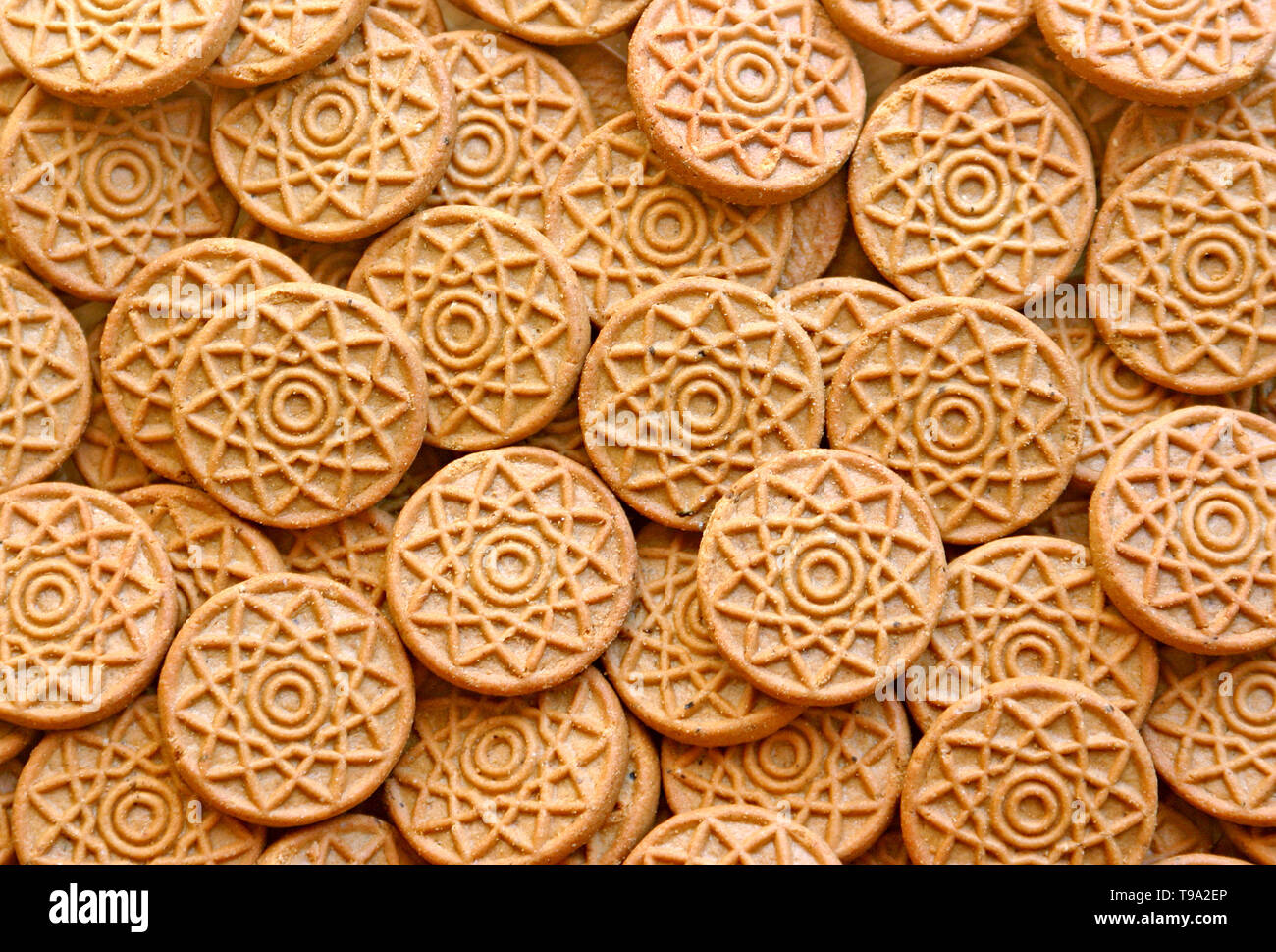 Full frame food background with brown round cookies, confectionery ...