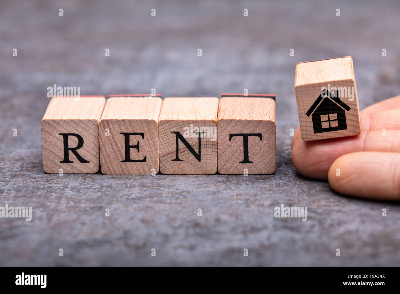 Close-up Of Person's Hand Placing House Icon Wooden Block Beside Rent ...