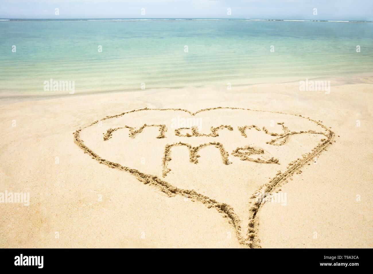 Close-up Of Marry Me Text Inside The Heart On Sand At Beach Stock Photo ...