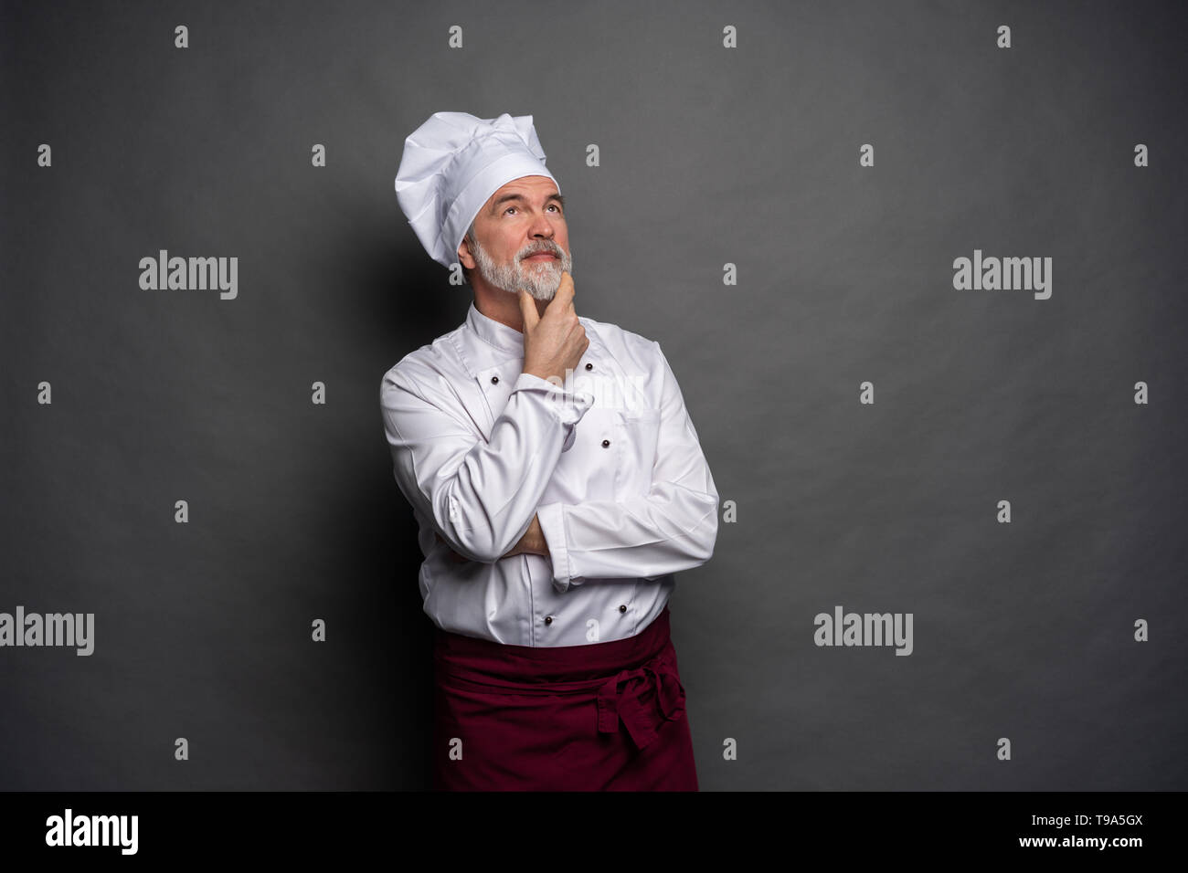 Image of chef planing what to cook on gray background.Chef thinking ...