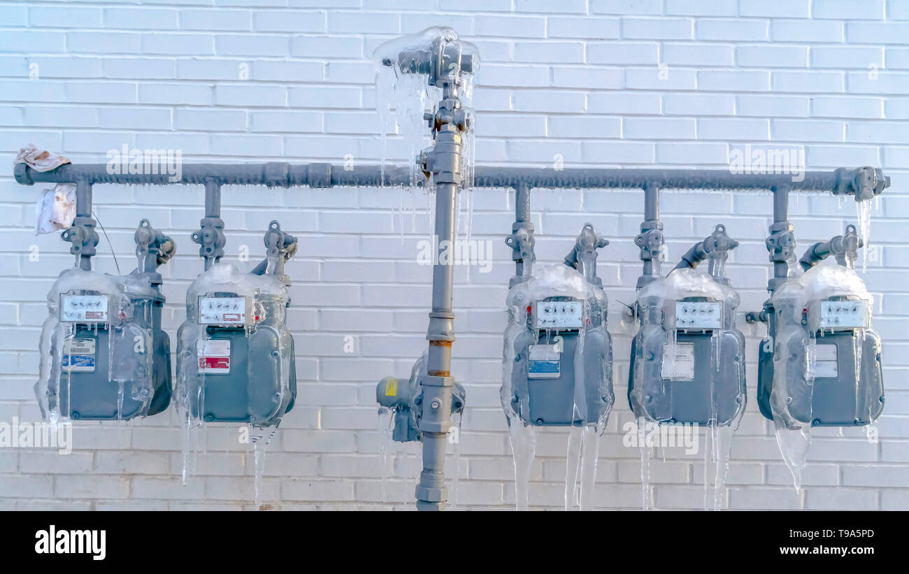 Clear Panorama Water meters and pipes covered with ice during winter in ...