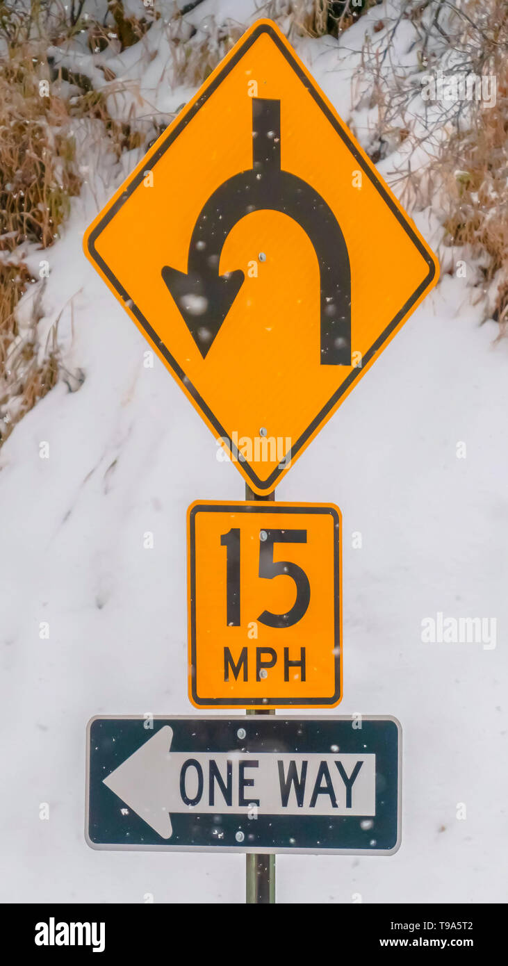 Vertical Road signs against snow covered slope in winter Stock Photo ...