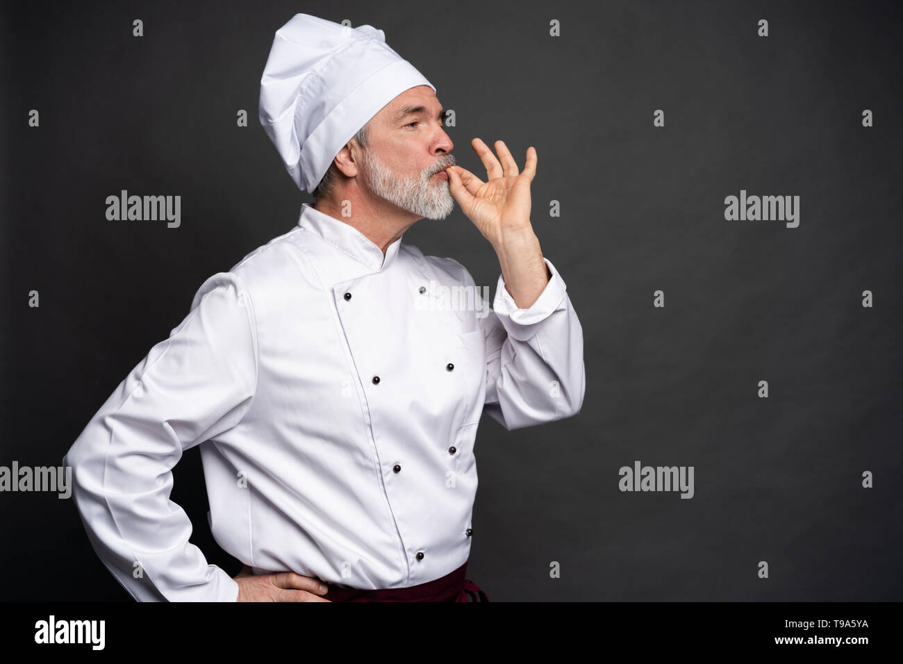 Chef making tasty delicious gesture by kissing fingers. Confident ...