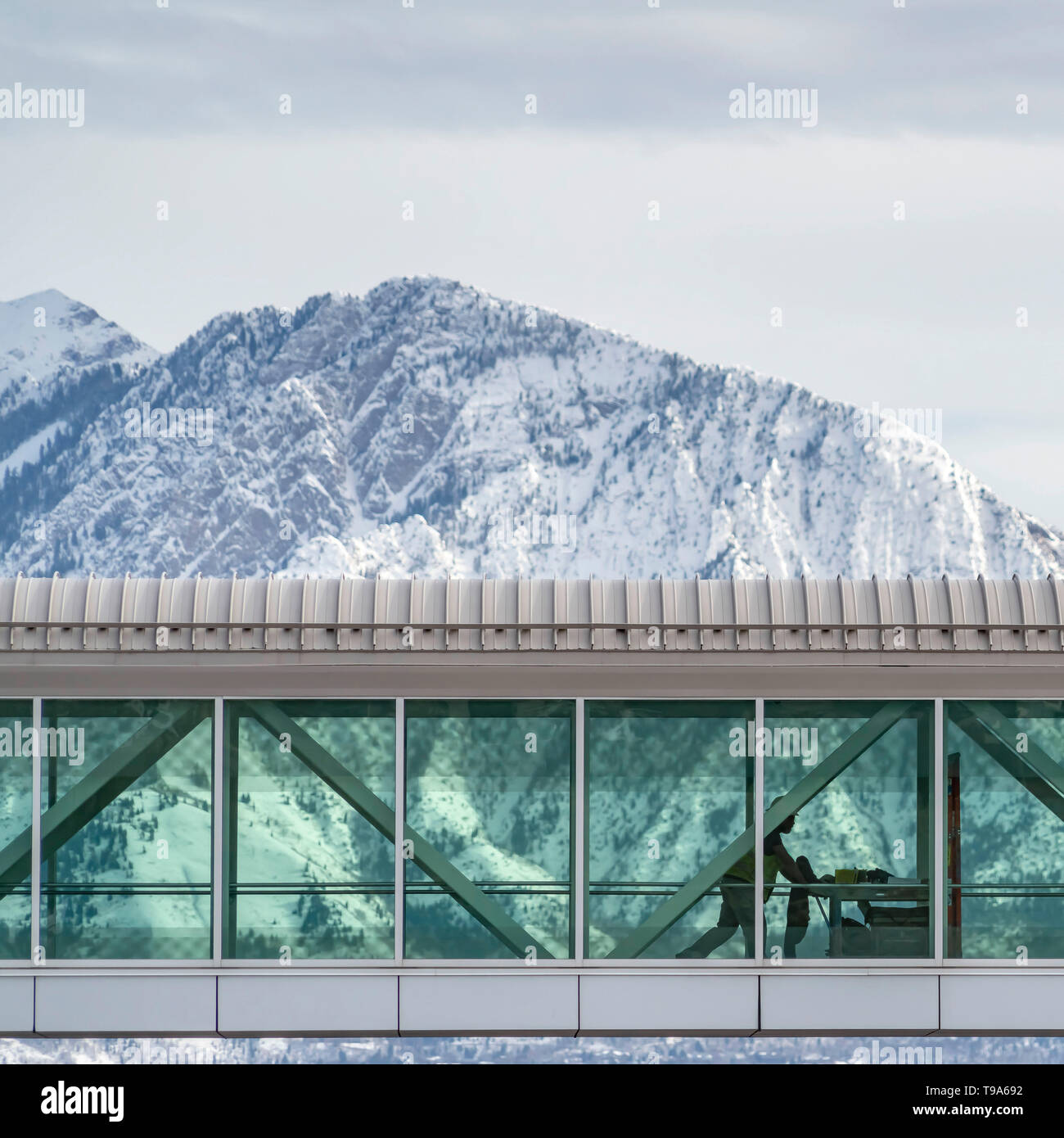 Square Skyway between buildings with a view of snowy mountain and ...