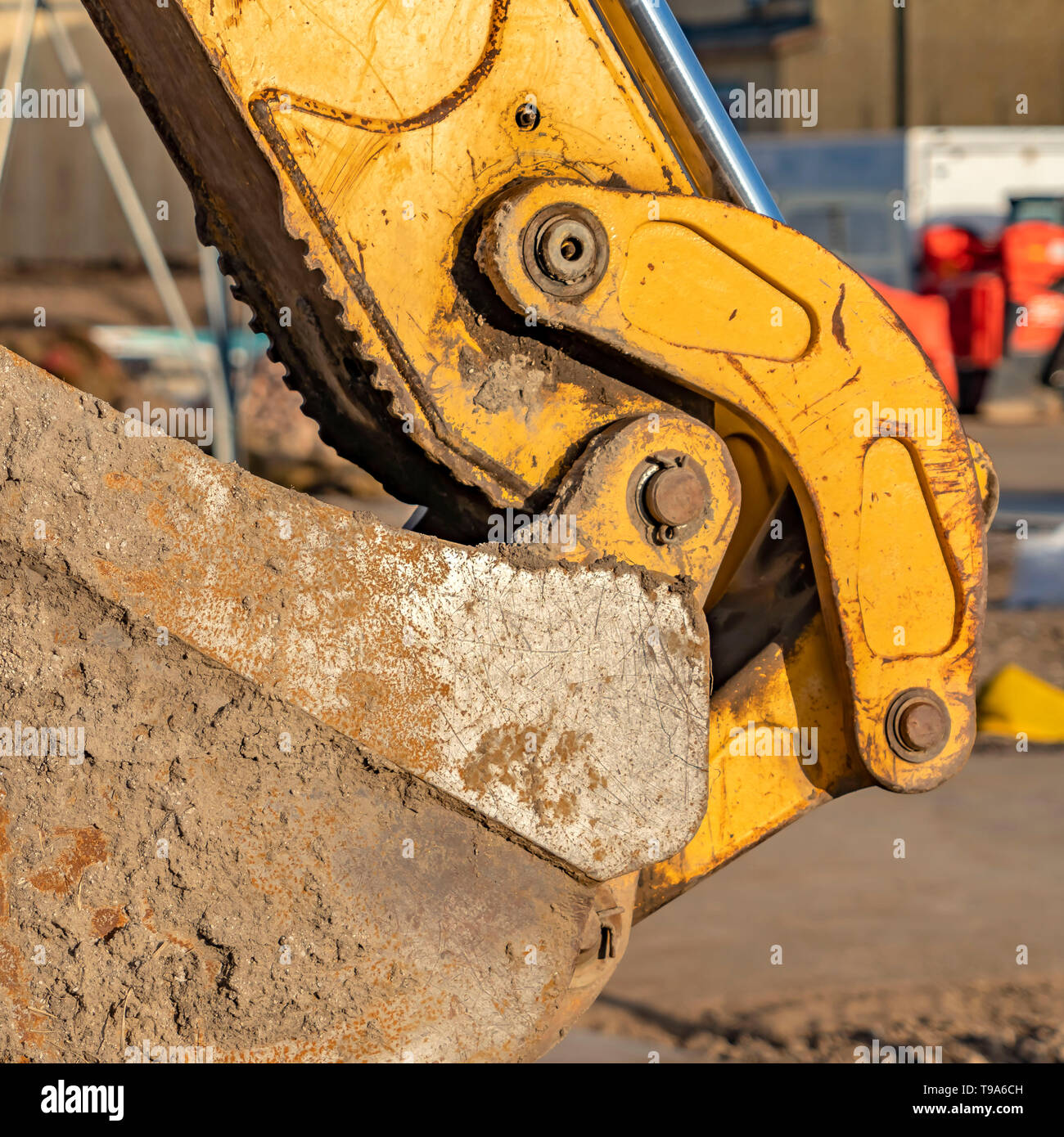 Clear Square The bucket of a yellow excavator viewed at a construction ...