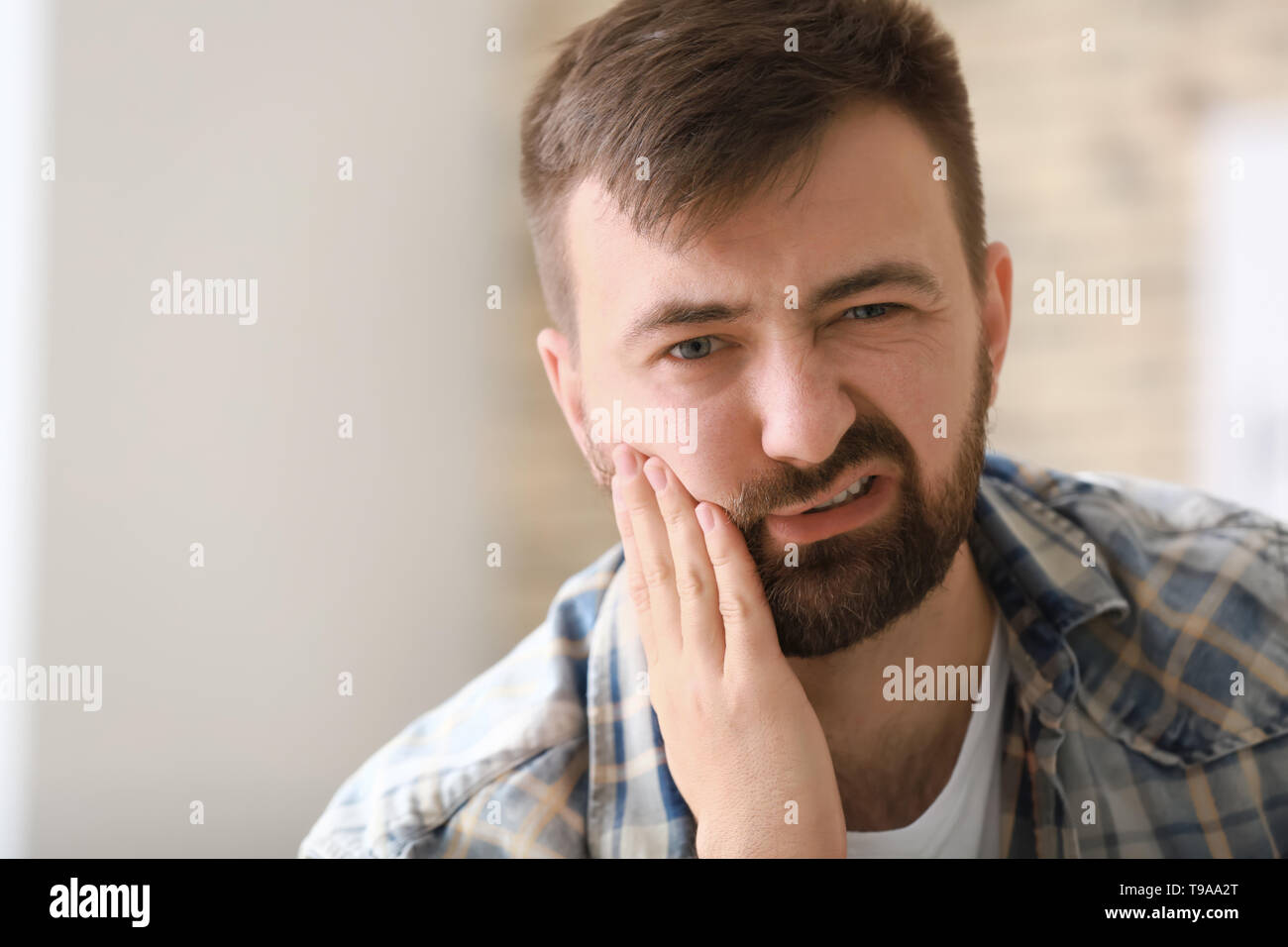Man suffering from toothache at home Stock Photo - Alamy