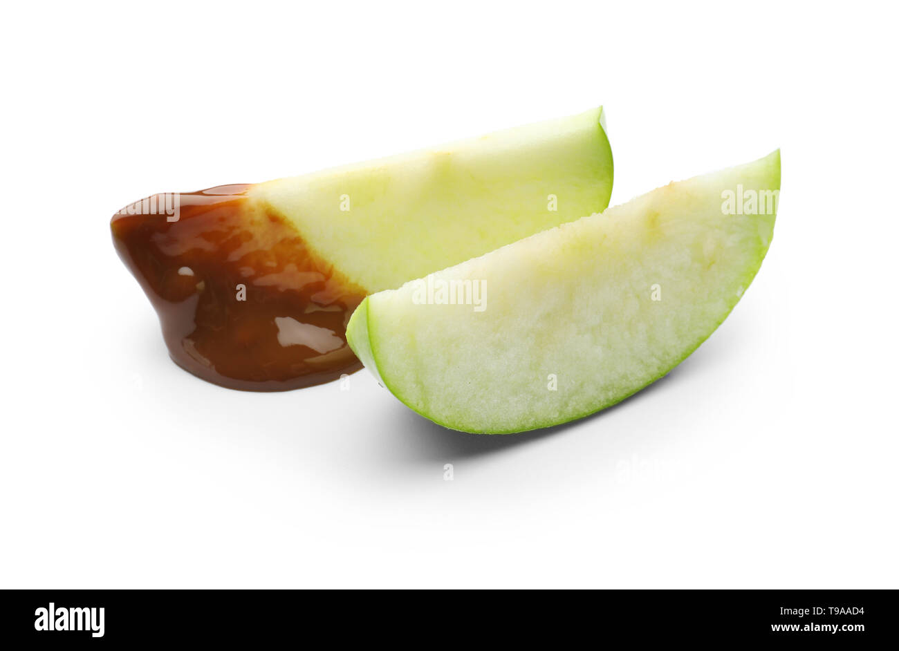 Apple wedges with sweet sauce on white background Stock Photo - Alamy