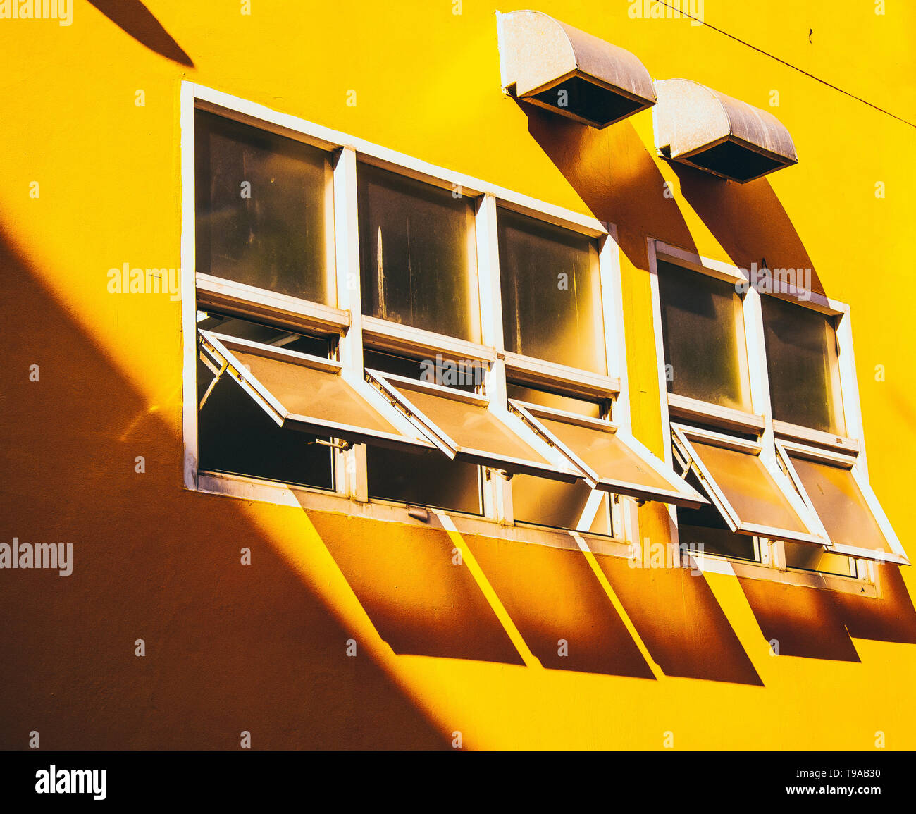yellow wall with glass window frame. shadow through glass summer ...