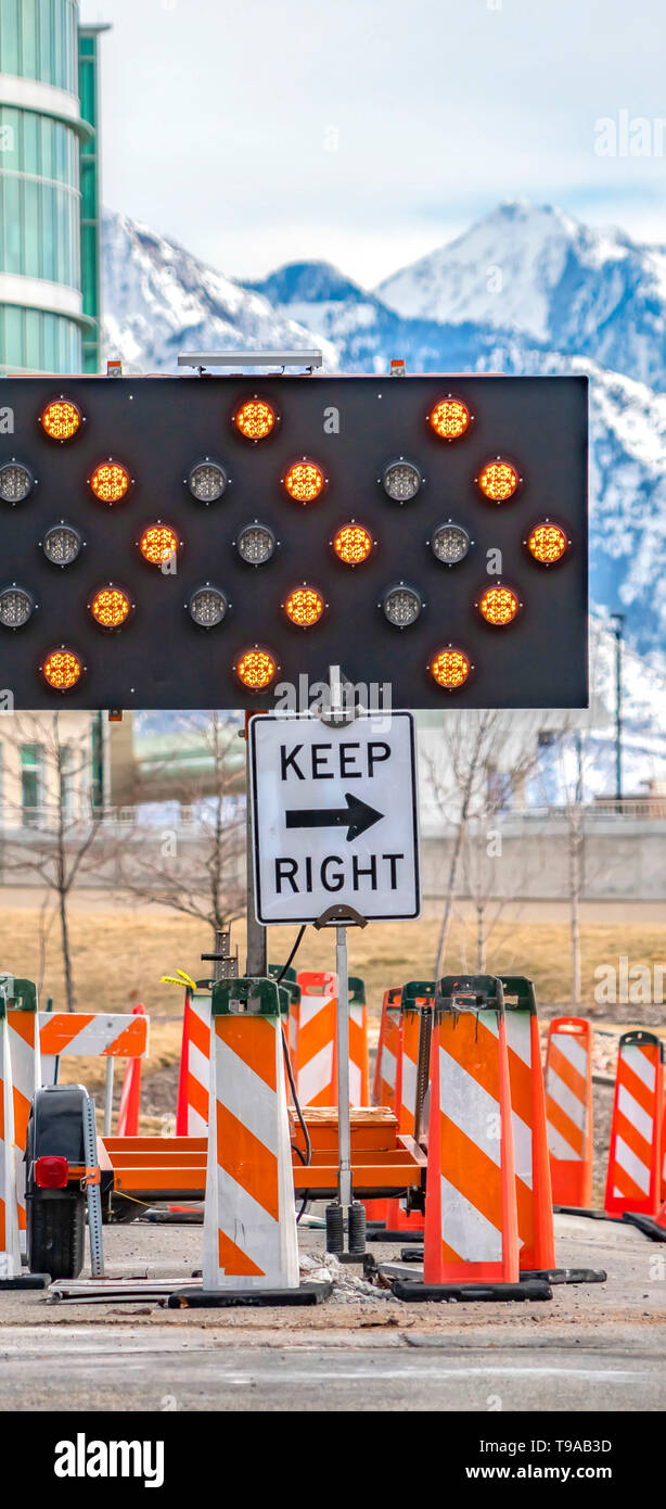 Vertical Keep Right sign underneath an arrow board surrounded by road ...