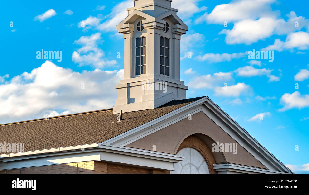 Panorama Exterior of a beautiful church with a white steeple against ...