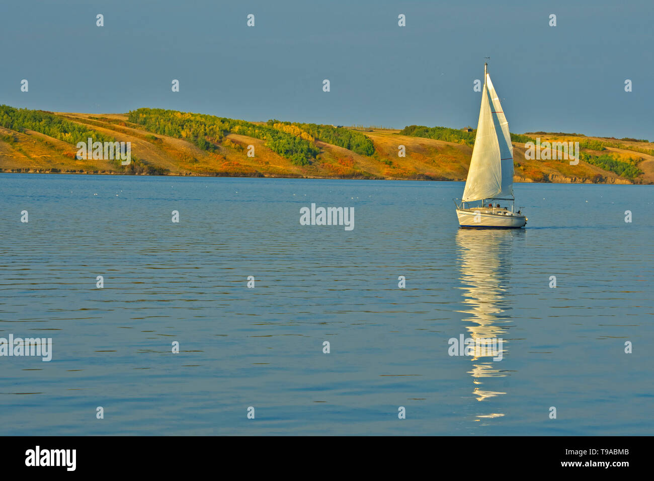 Sailboat in Lake Manitou, a saltwater lake on the Canadian priaires ...