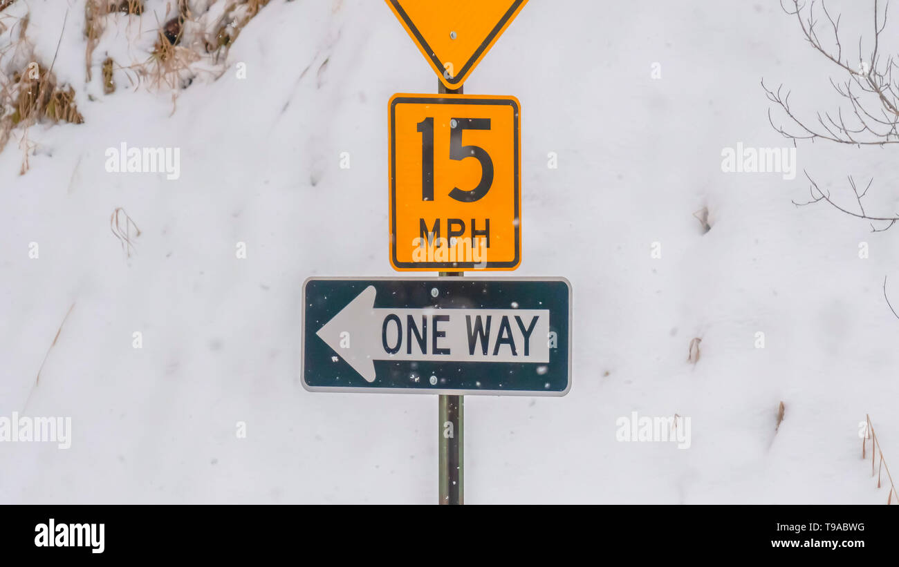 Panorama Road signs against snow covered slope in winter Stock Photo ...