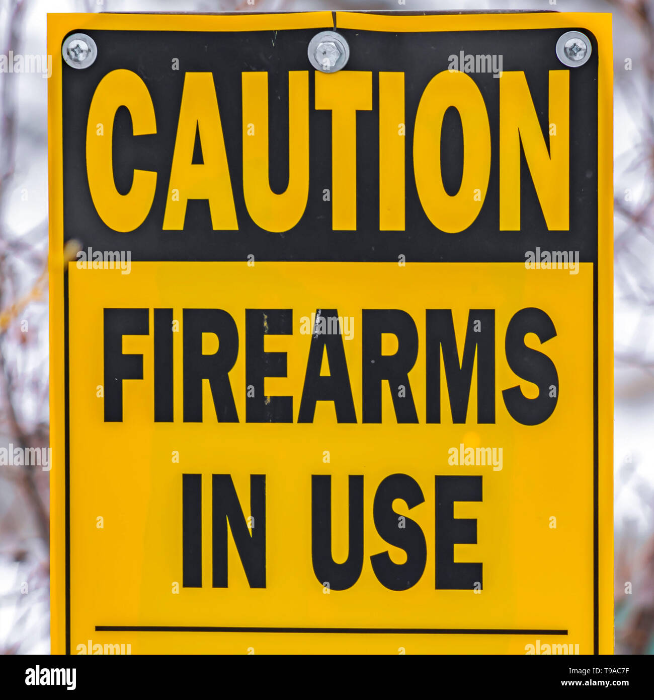 Clear Square Close up of a yellow sign that reads Caution Firearms In ...