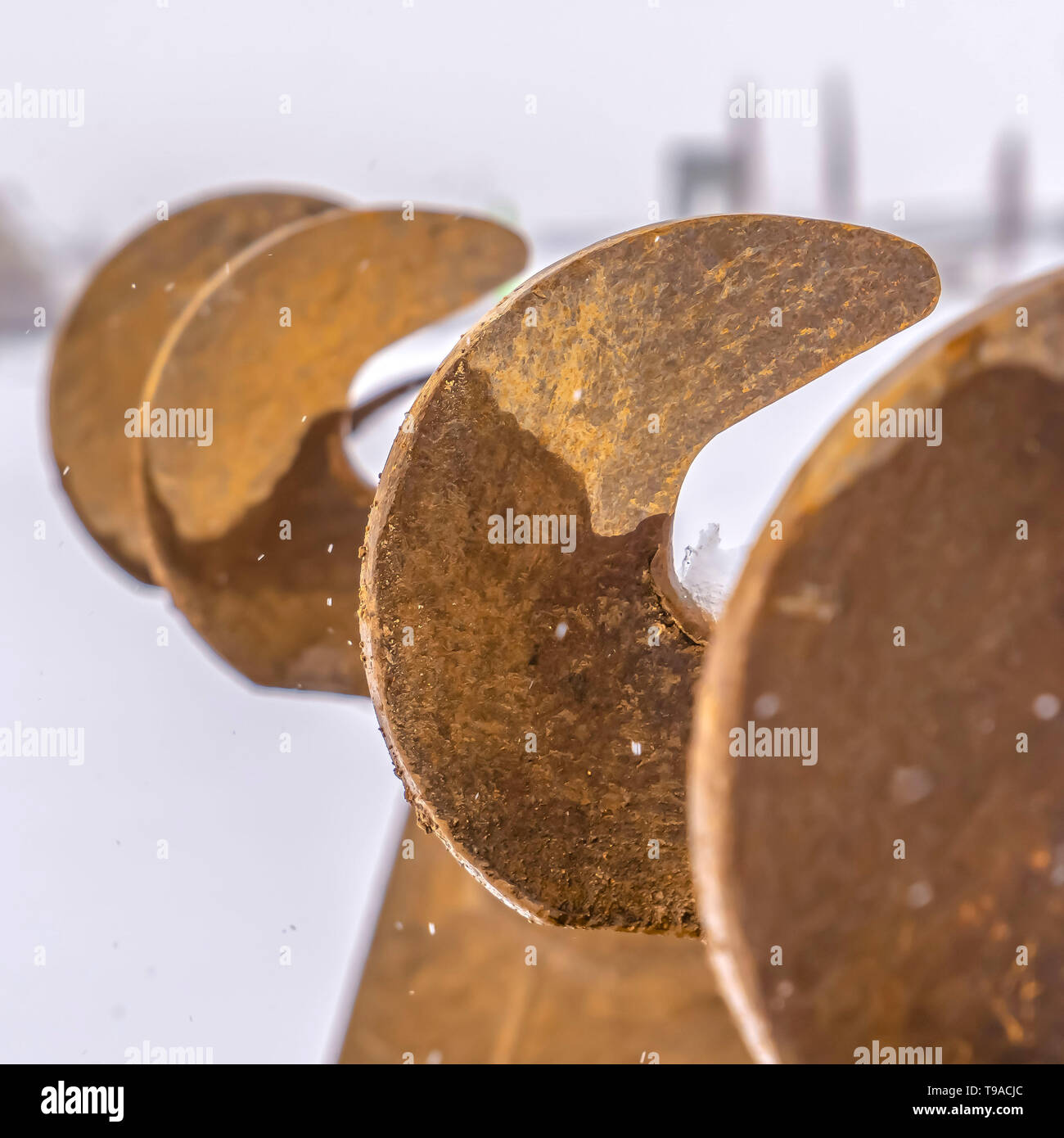 Square Teeth of an excavator bucket against a snowy landscape in ...
