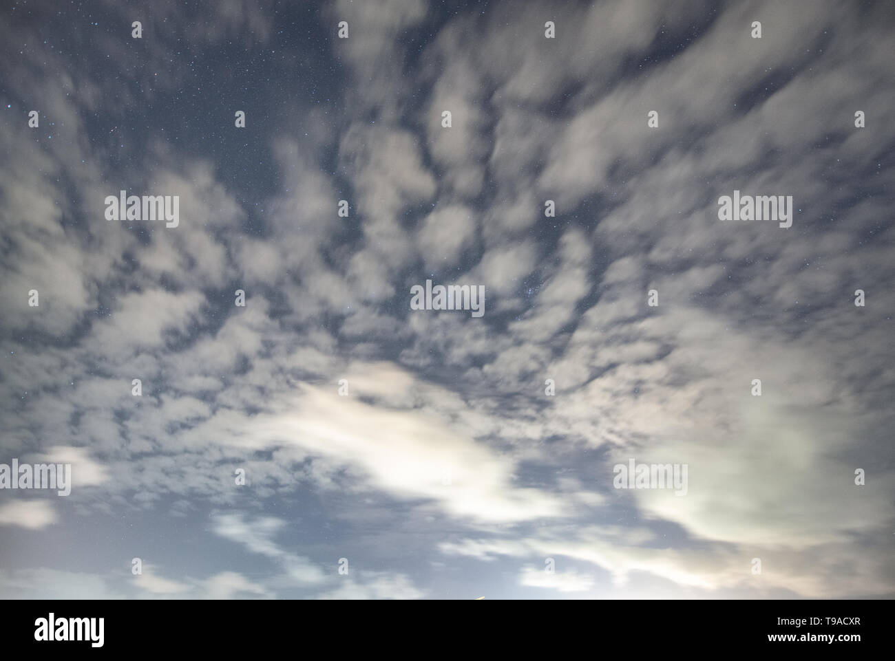 Cloudy sky with stars at night Stock Photo - Alamy