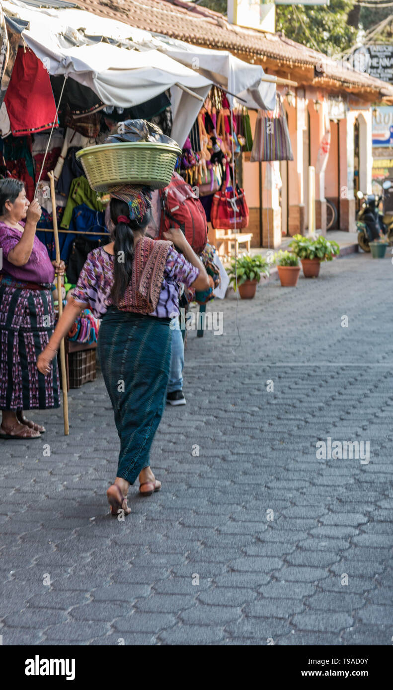 Indigenous Guatemalan woman in traditional clothing, walking on a ...