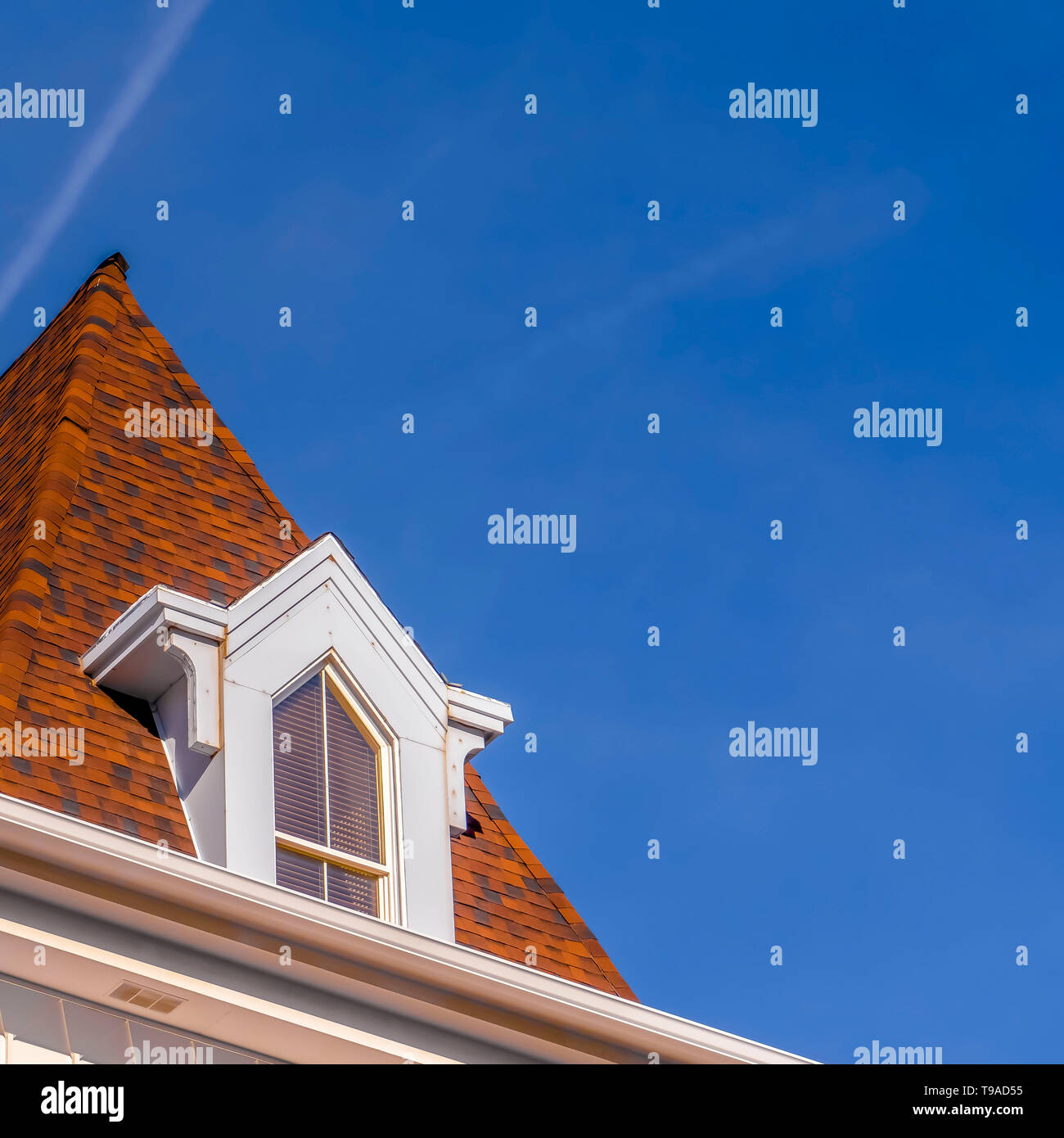 Square Roof and steeple of a building with vibrant blue sky in the ...