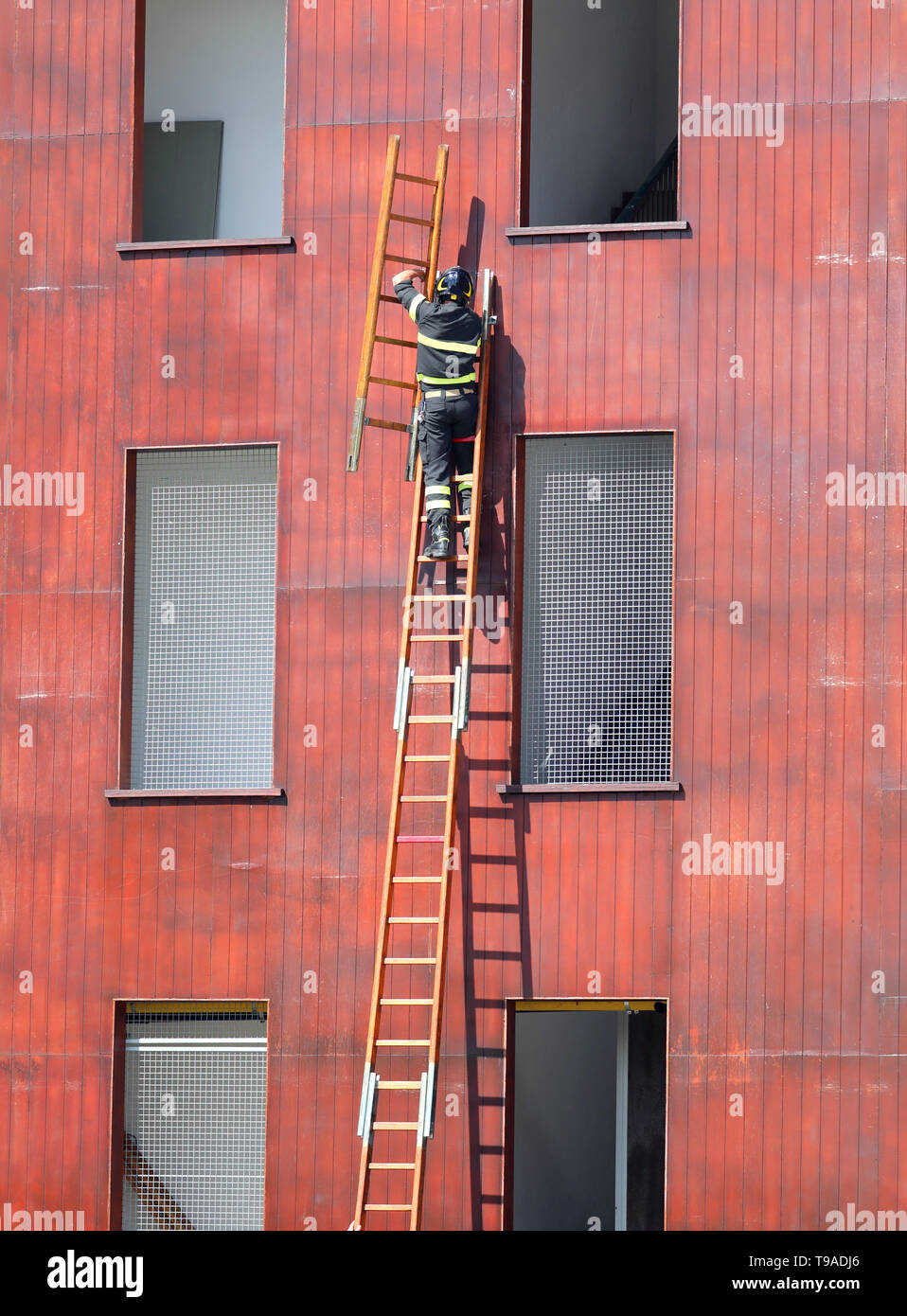 rescue exercises with the ladder and fireman with helmet at the fire ...