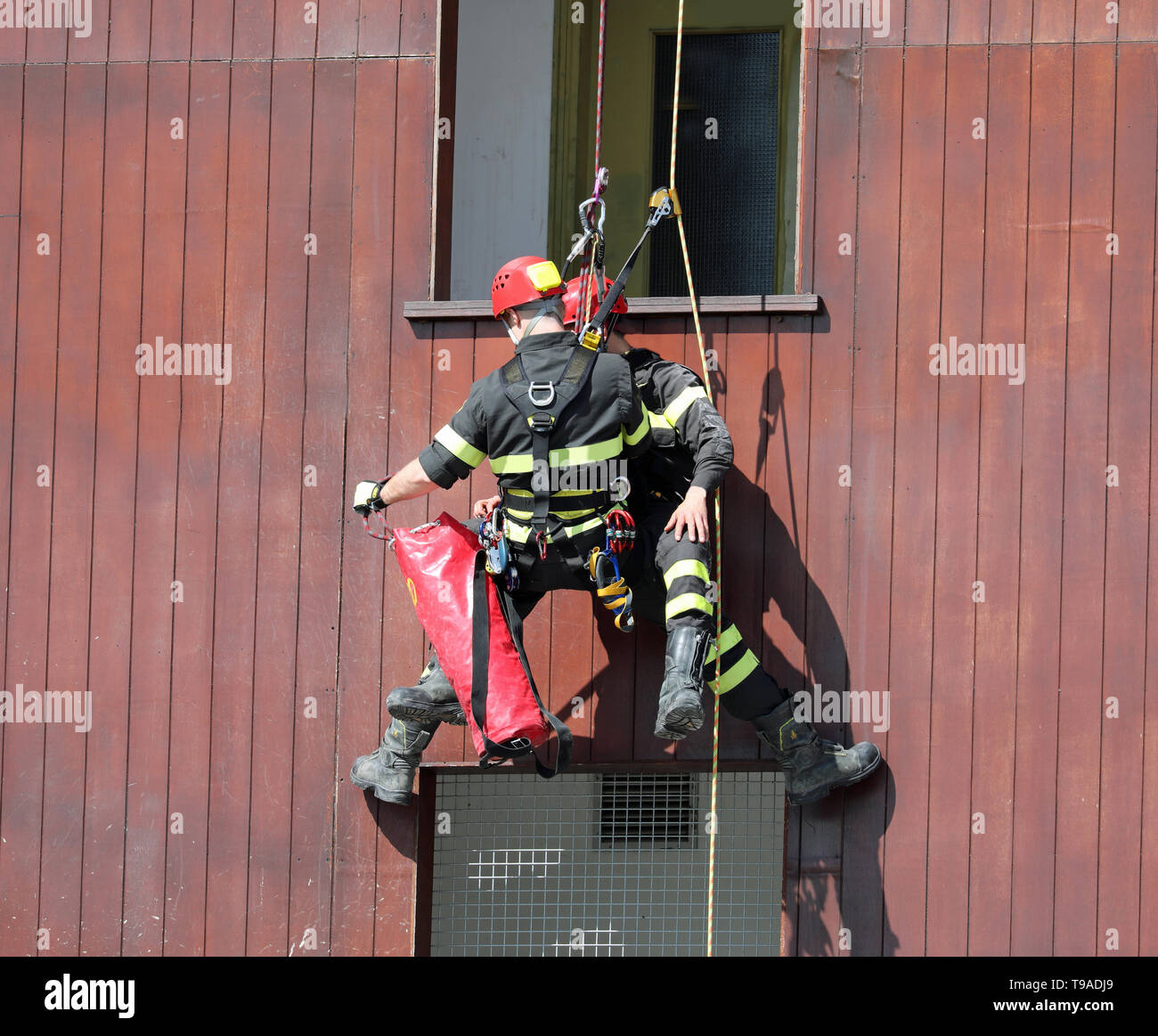 rescue exercises with abseiling by a firefighter and a person who ...
