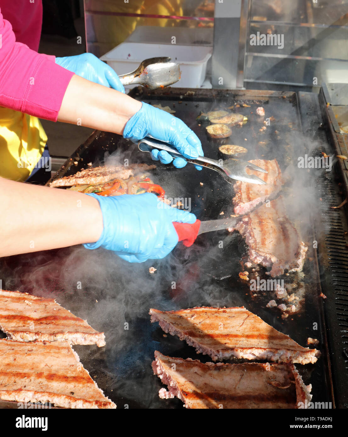 many pieces of meat cooked on the grill during a country festival Stock ...