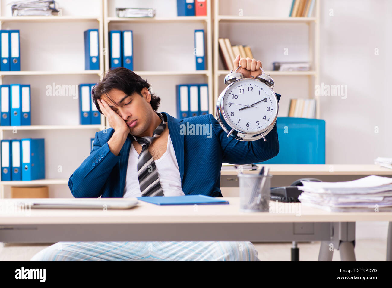 Employee coming to work straight from bed Stock Photo - Alamy