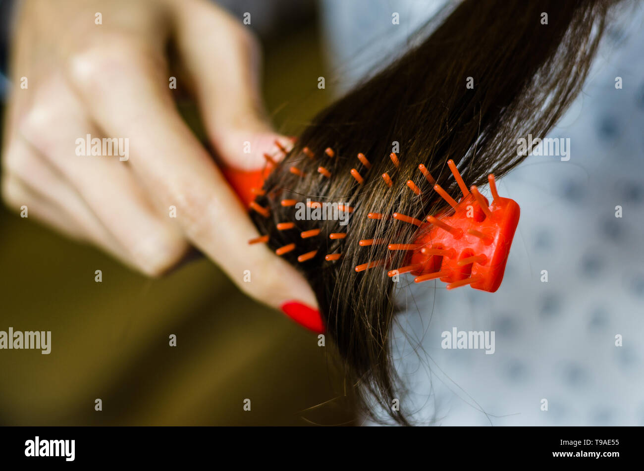 Young woman combing hair hi-res stock photography and images - Alamy