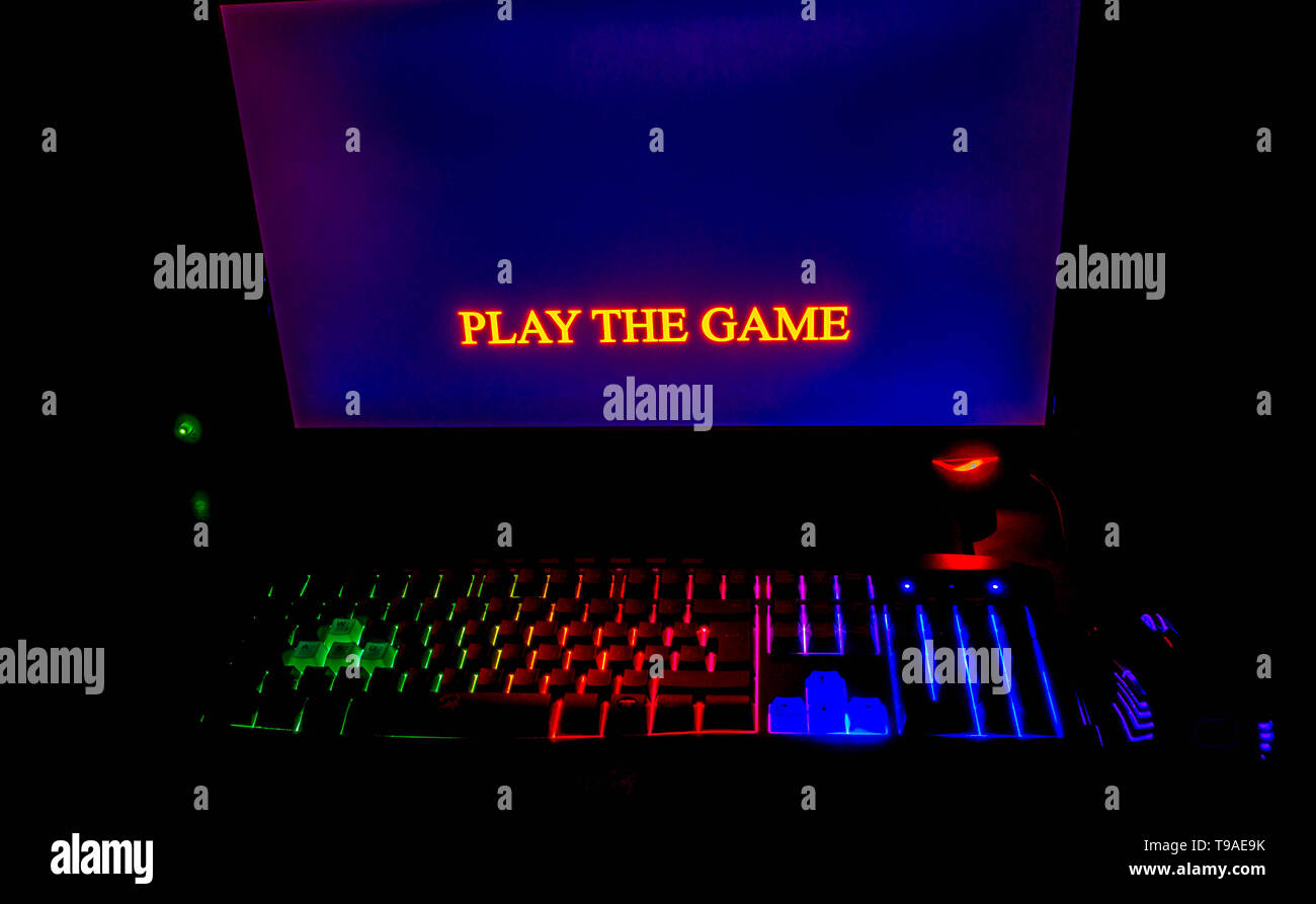 illuminated mea mechanical computer keyboard at nigh and hands ...