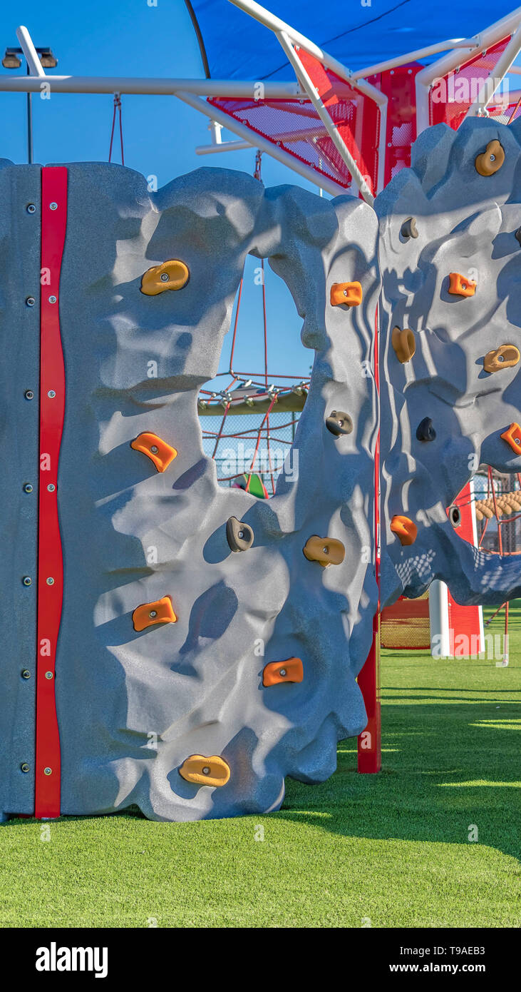 Clear Vertical Playground equipment at a park under blue sky on a sunny ...