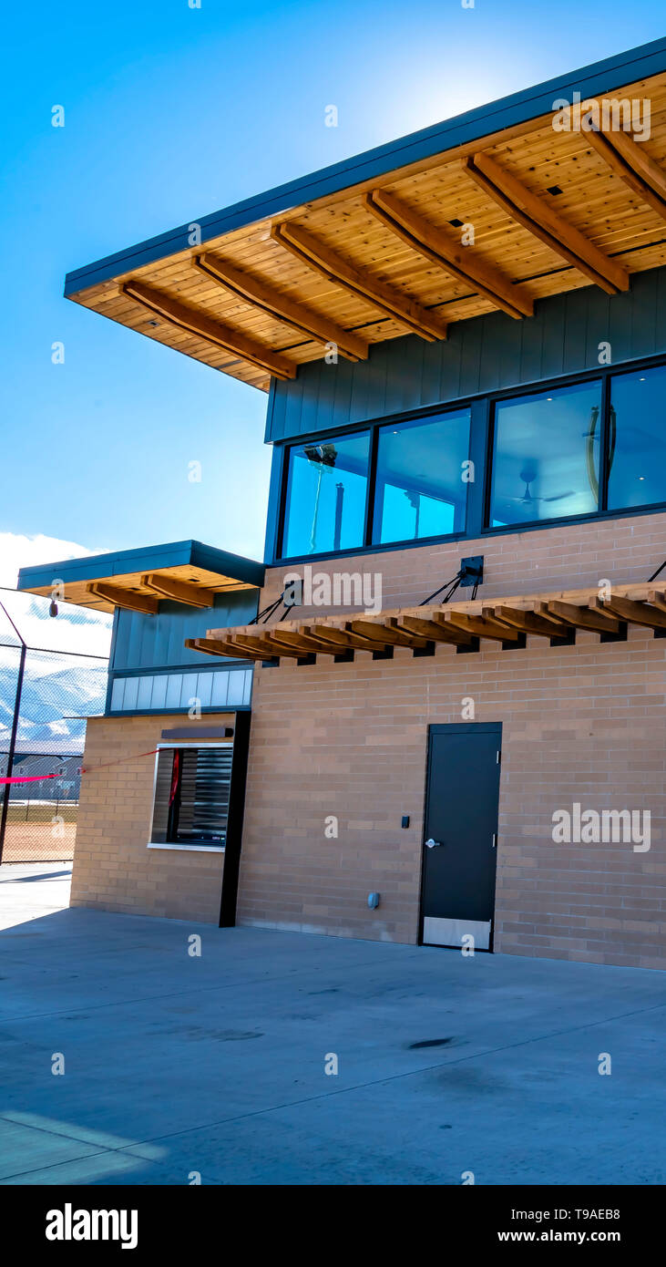 Clear Vertical Brick building with security camera at a park viewed on ...