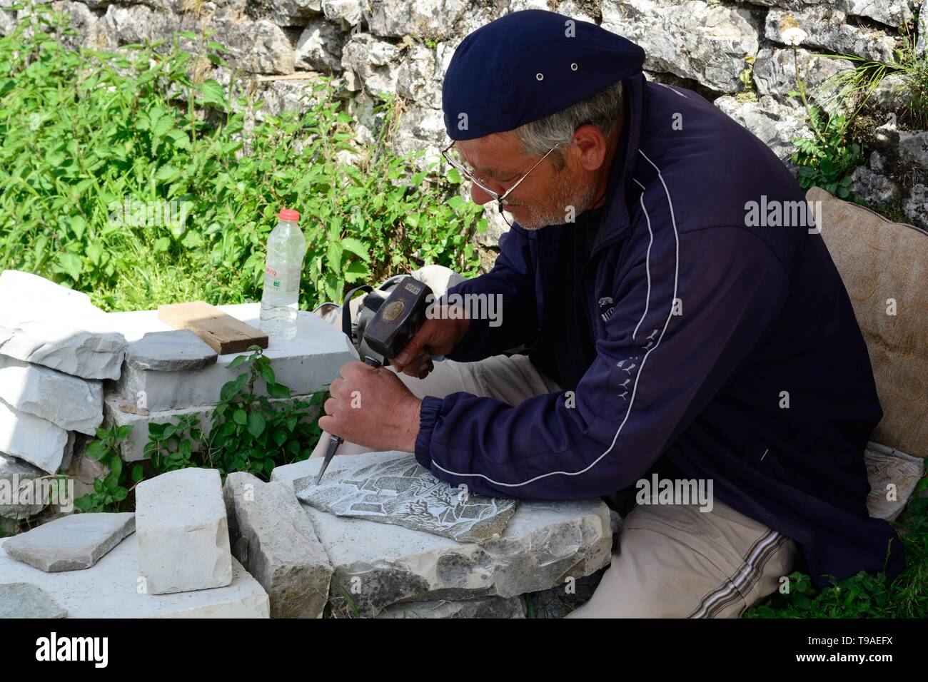 A stone mason carving a stone picture Girokastra Albania Stock Photo ...