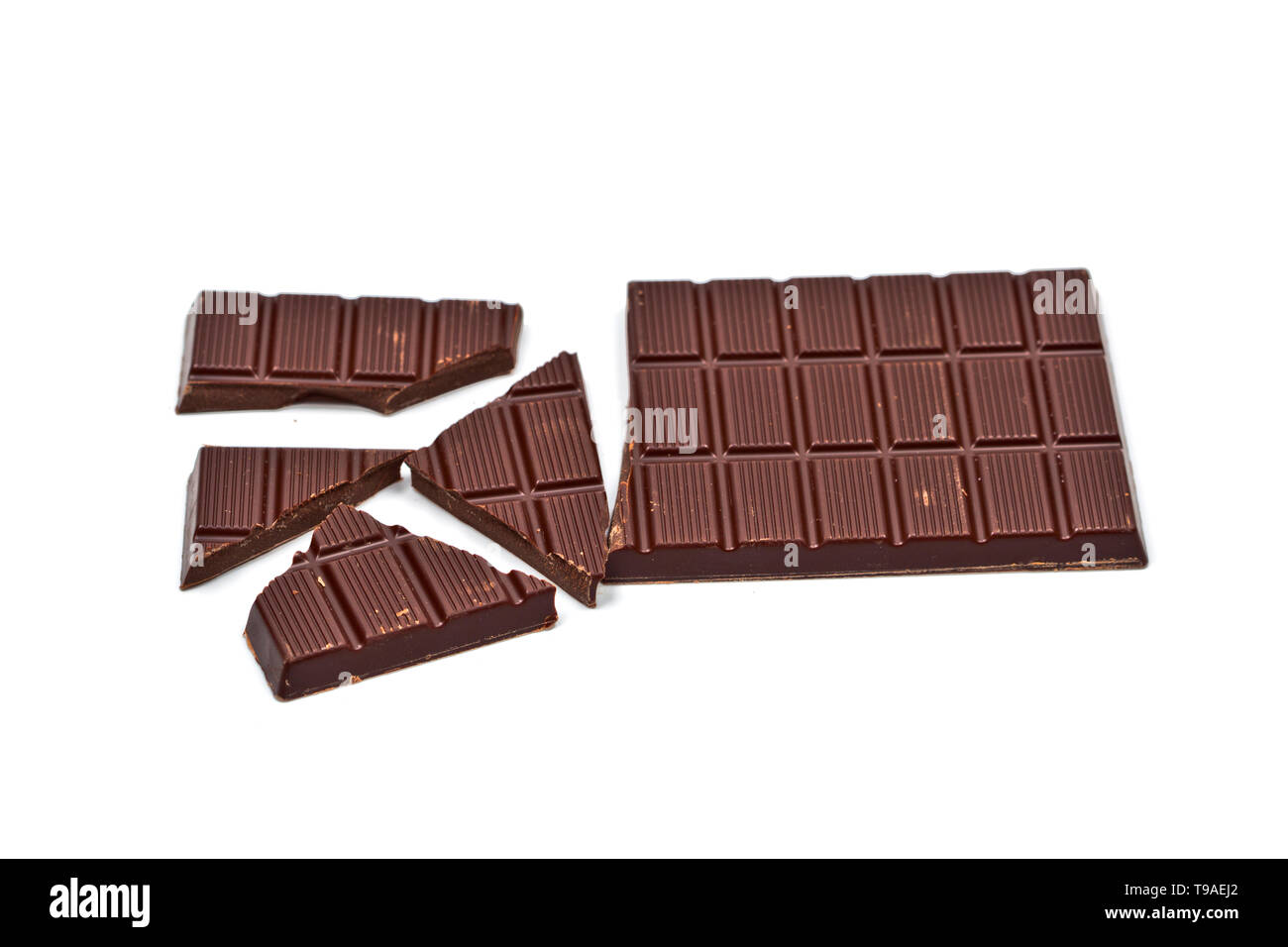 Broken dark chocolate bar isolated on white background Stock Photo - Alamy