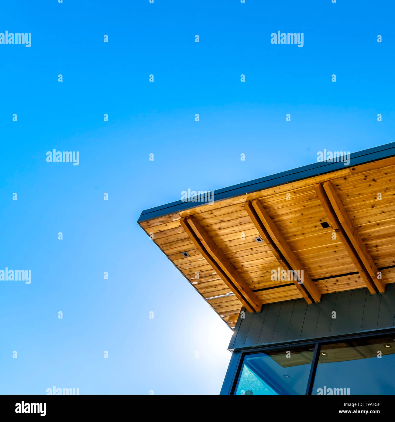 Clear Square Building with flat roof and red brick wall under clear ...