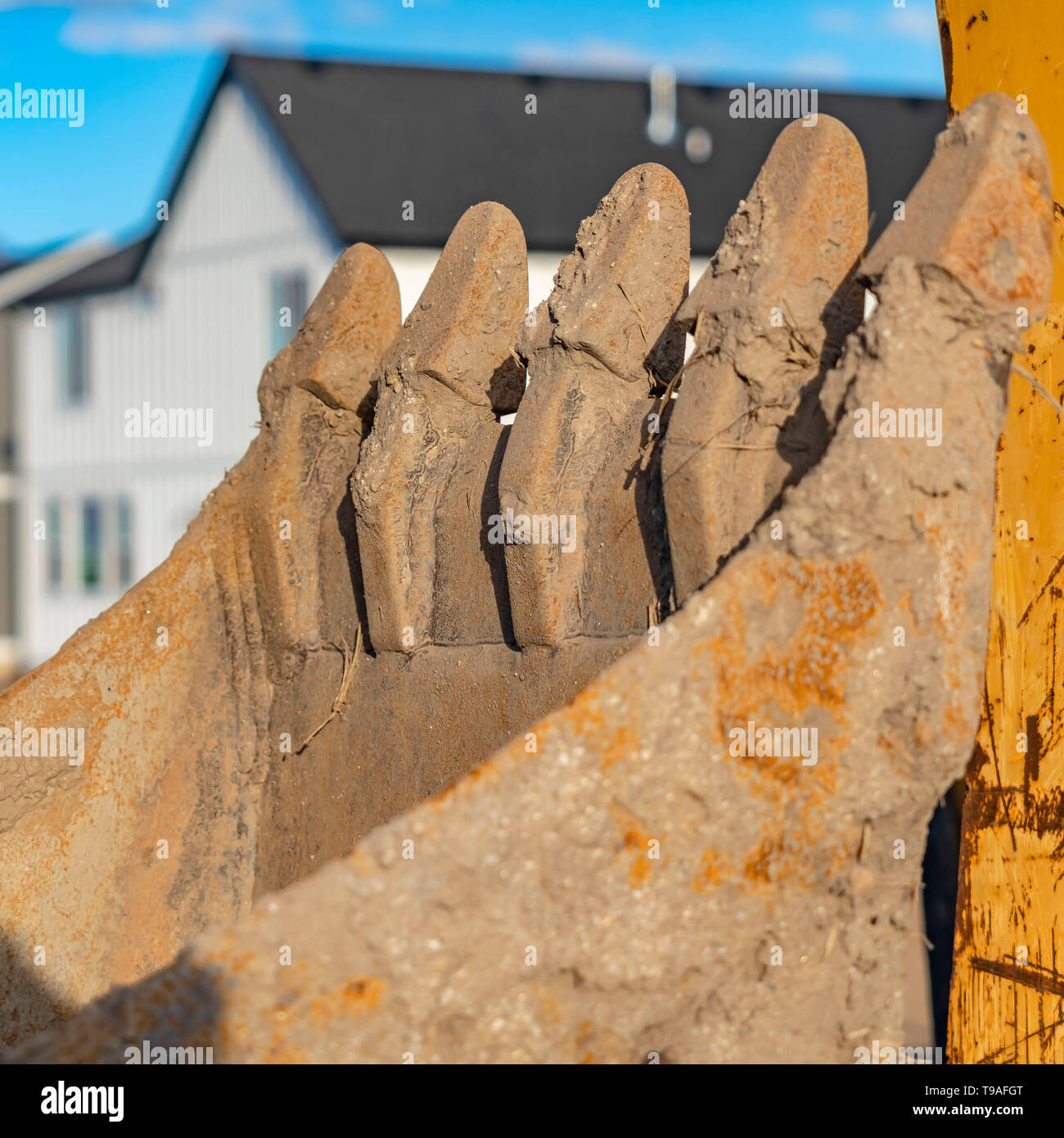 Clear Square Dirty and rusty metal bucket teeth of an excavator viewed ...