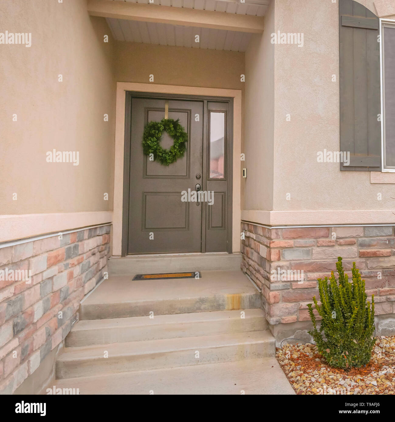 Clear Square Pathway and stairs leading to the gray front door with ...