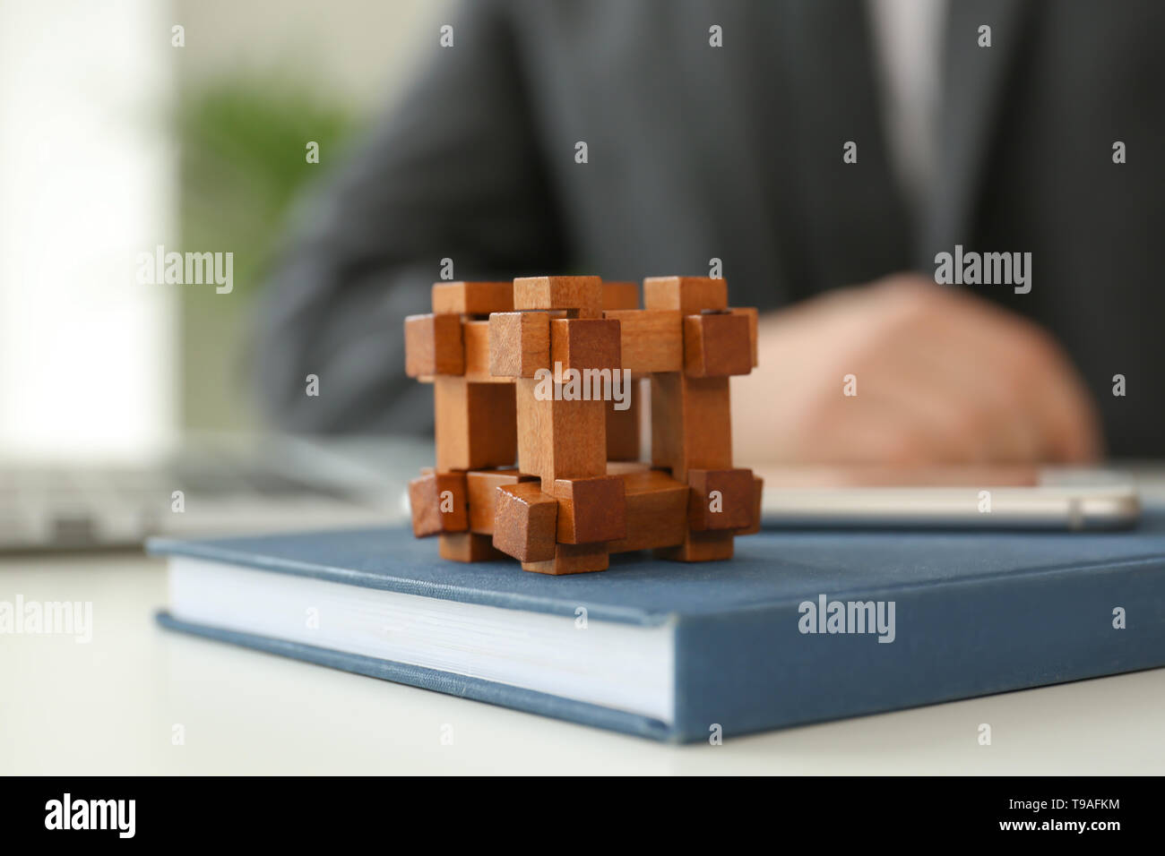 Brain teaser on table of businessman Stock Photo - Alamy